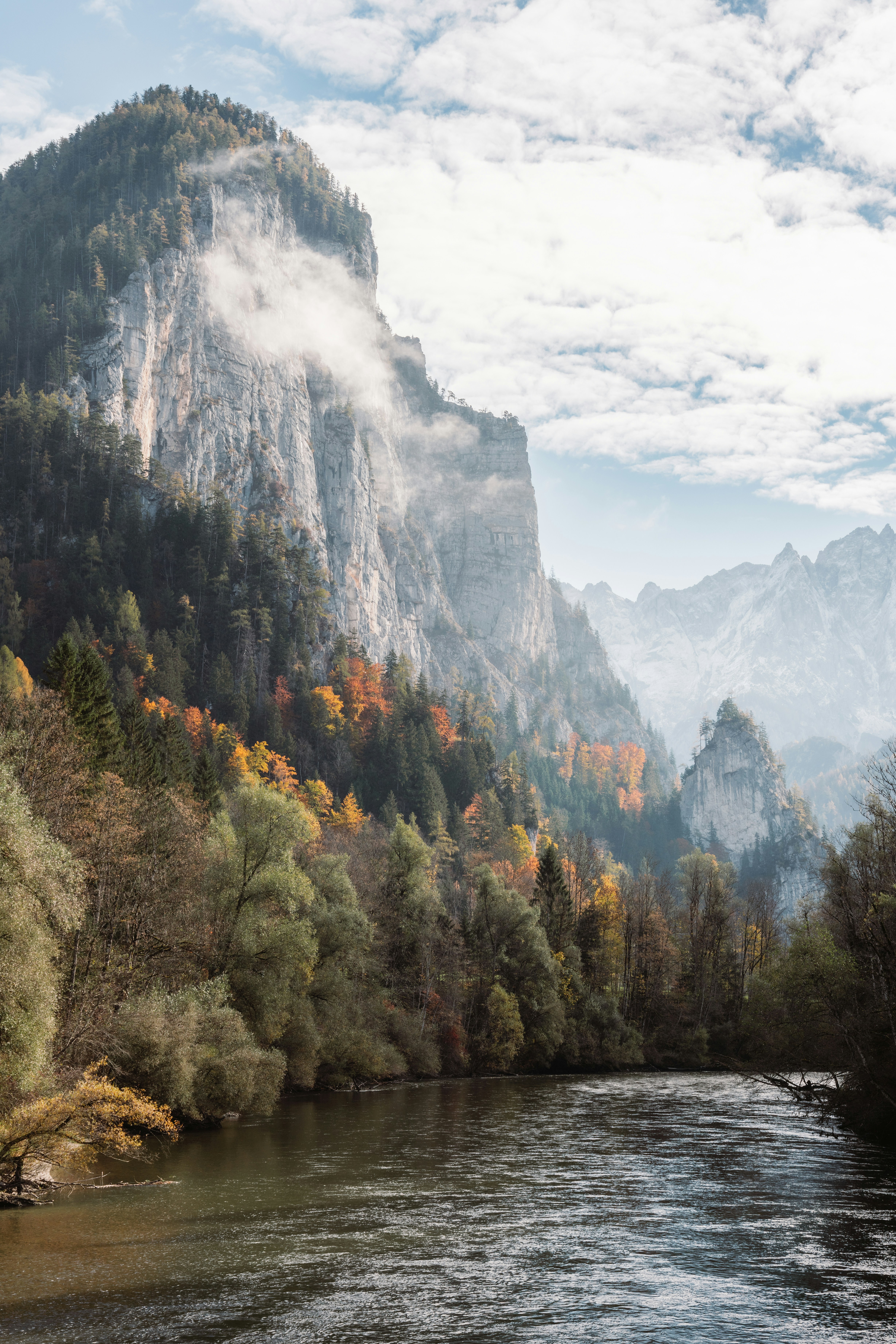 Misty cliffs and tranquil river: autumn hush beneath towering granite