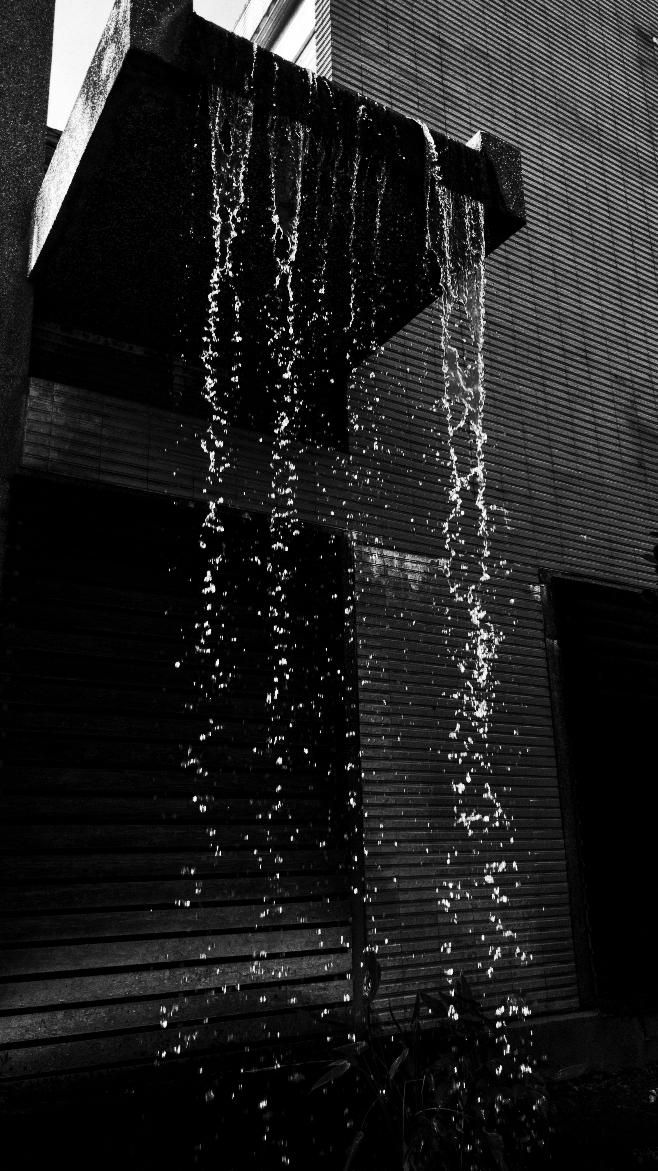 Water cascading down a brick wall