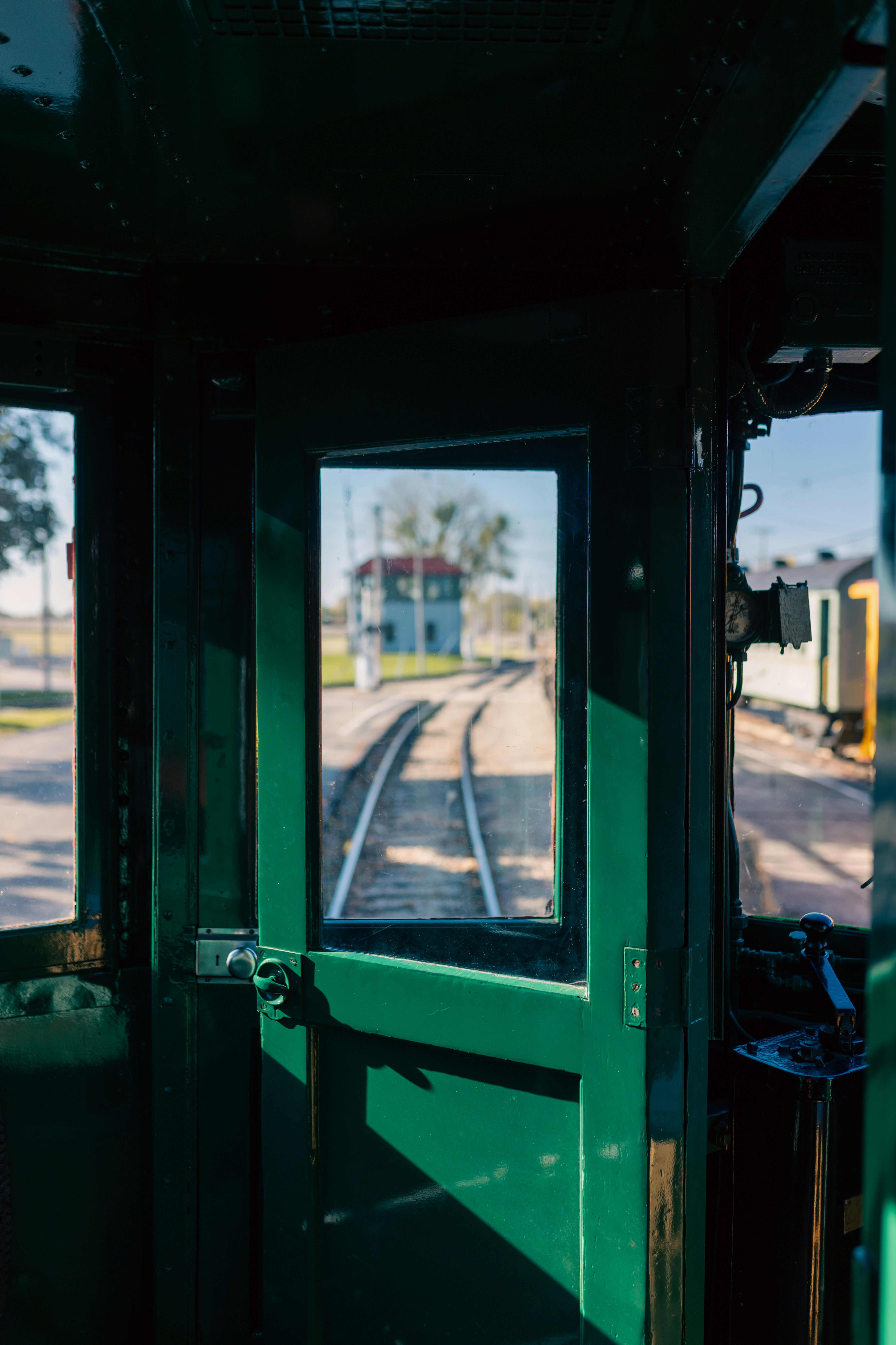 Green Cabin Portal: Railway Tracks in View Through a Cabin Window