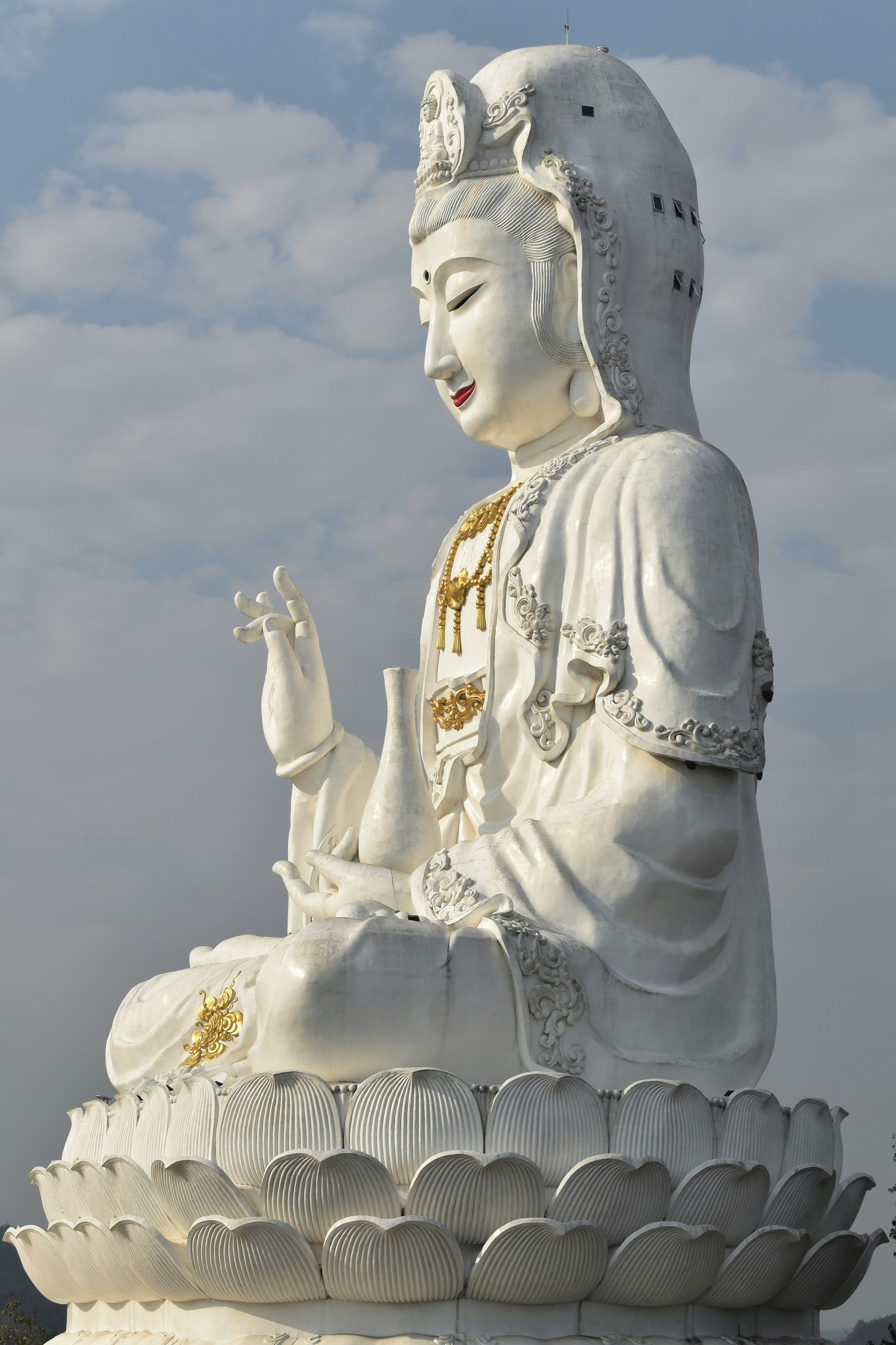 Graceful Serenity: The White Buddha Emerges Above Clouded Seas