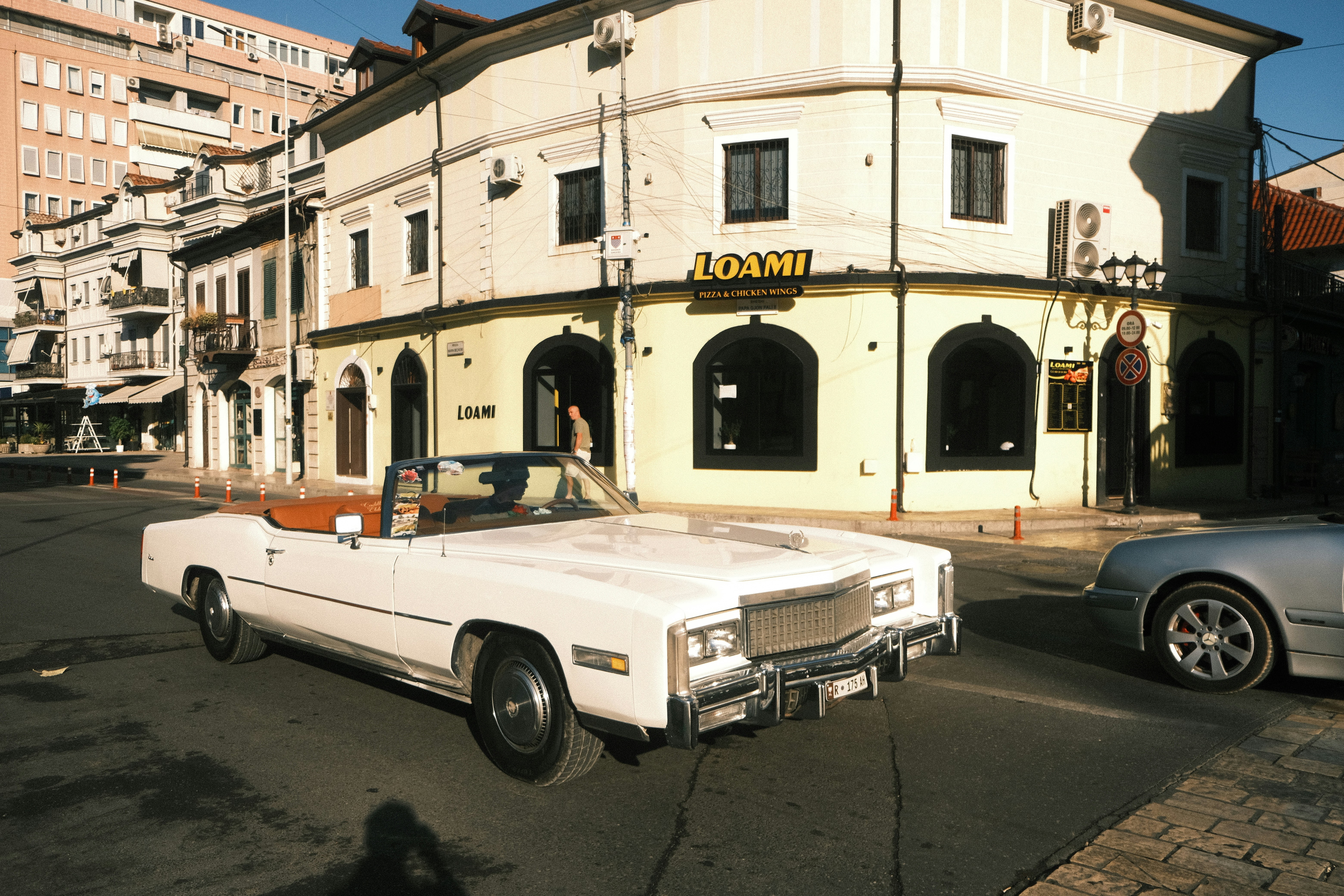 White Convertible on a Sunlit Street in Historic Mediterranean Quarter