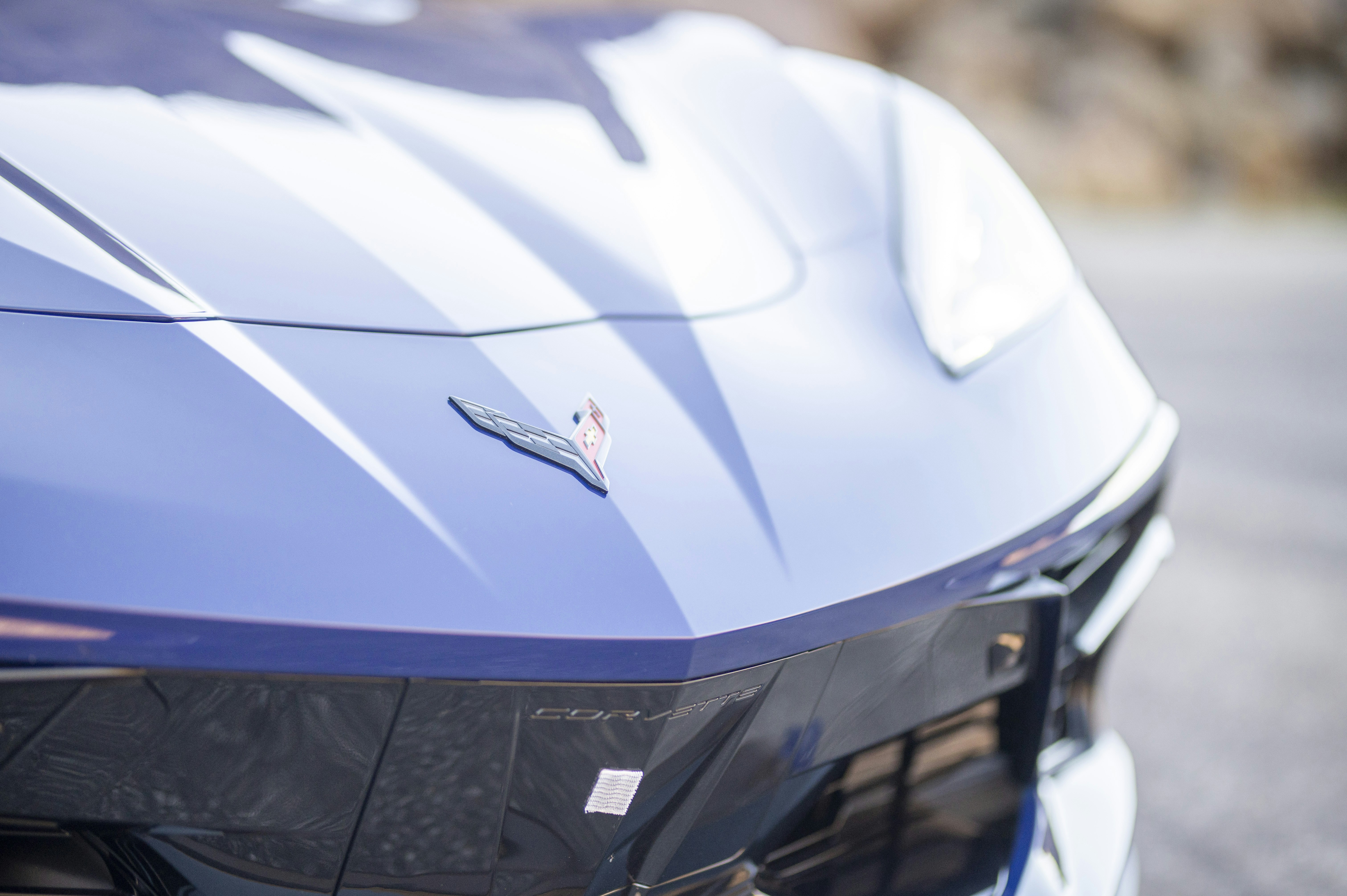 Chrome Crest: The Corvette Emblem on a Deep Blue Hood