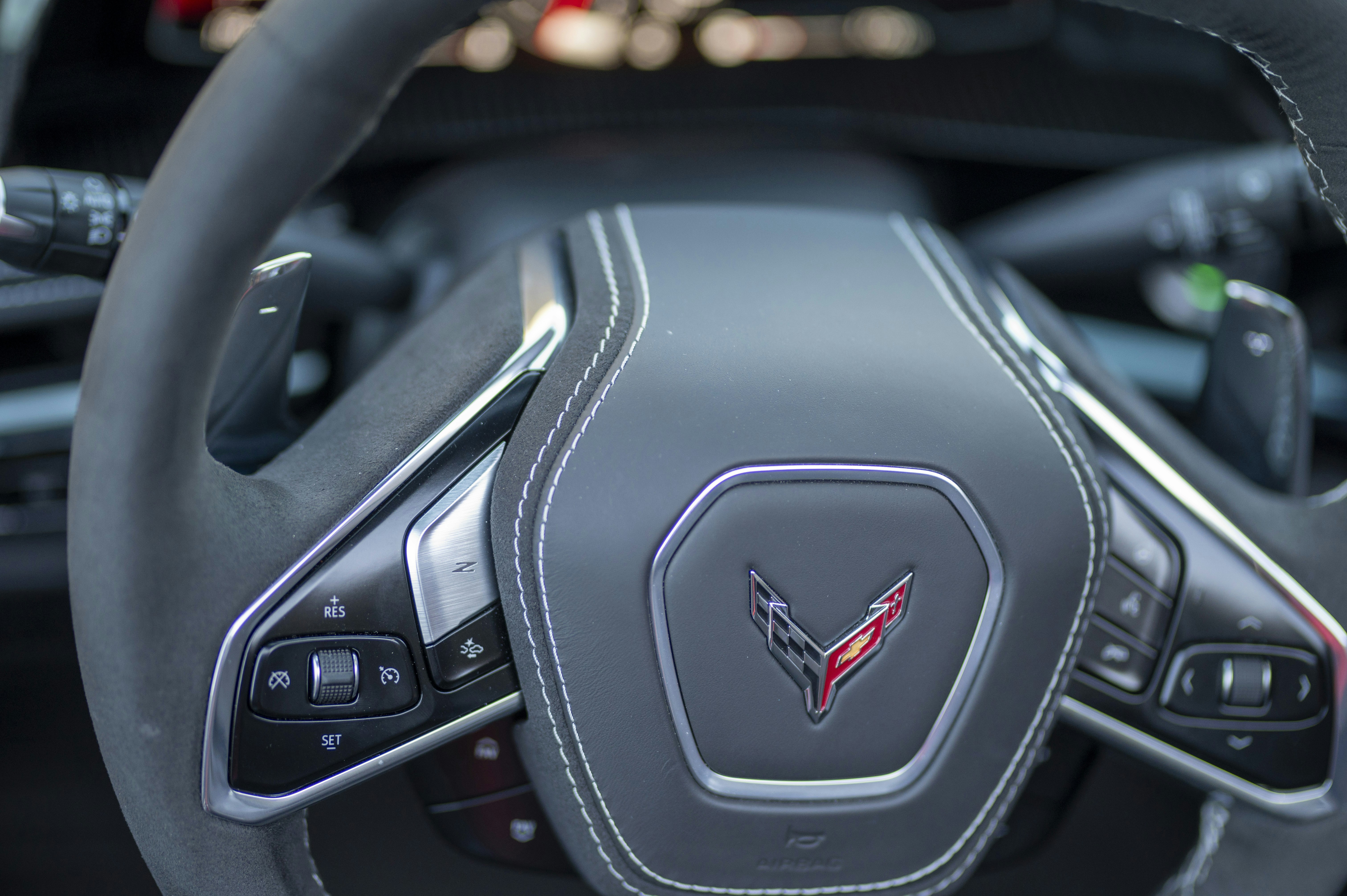Center Stage: The Corvette Emblem Framed by a Sculpted Steering Wheel