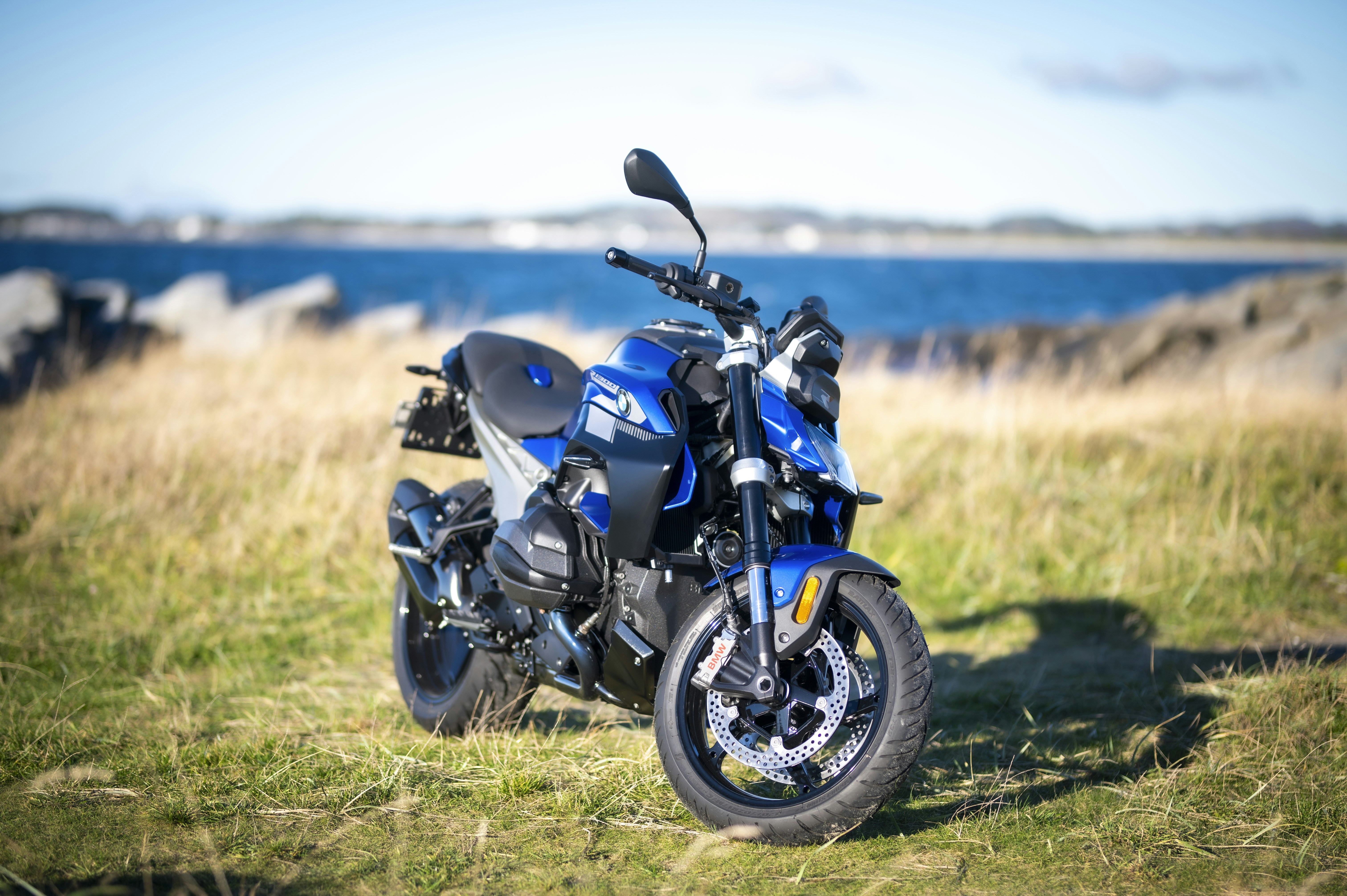 Blue Sport Duo: A Stout Streetbike Paired Against Coastal Grass