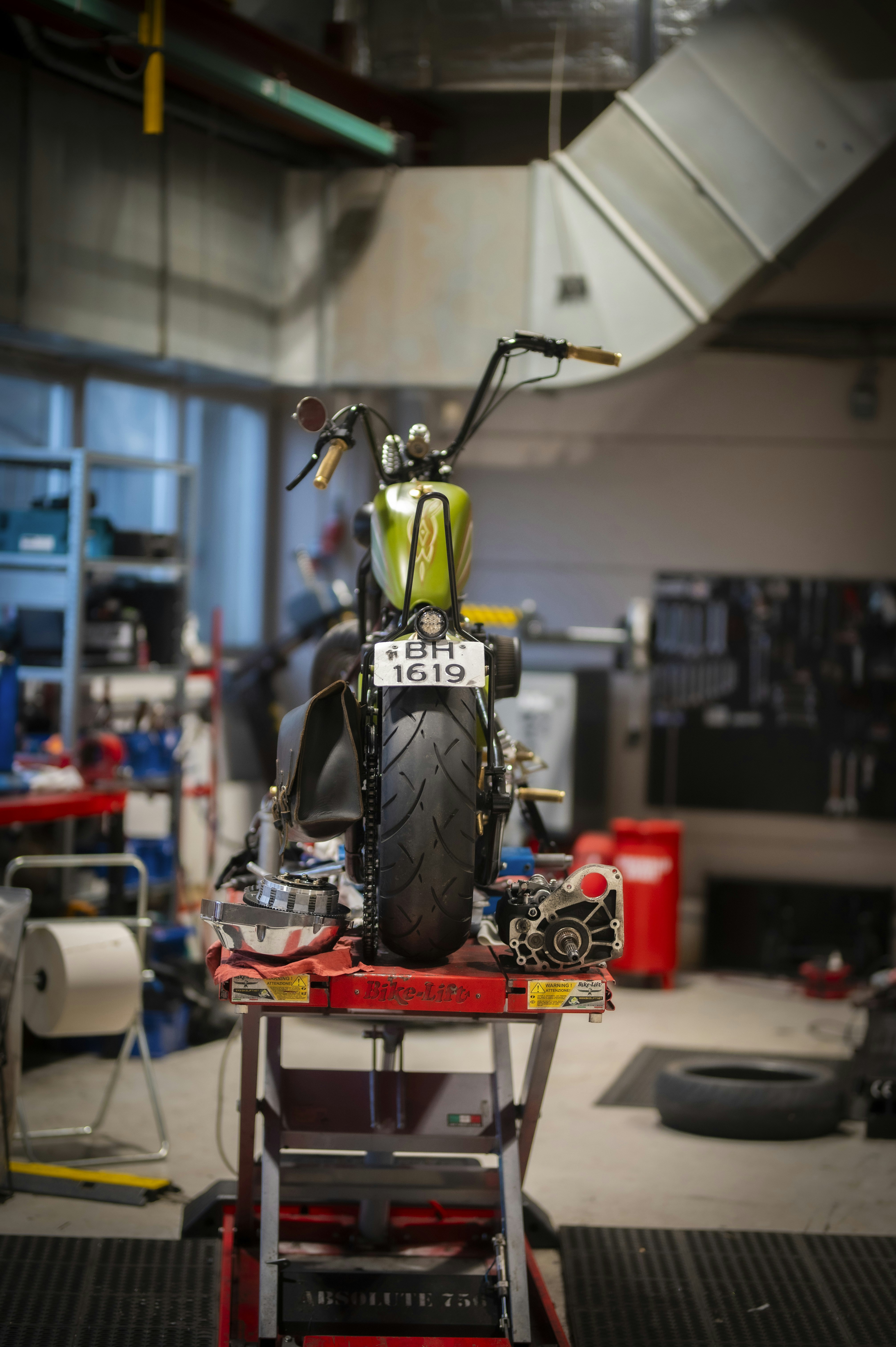 Green Motorbike on a Workbench: Industrial Studio Still