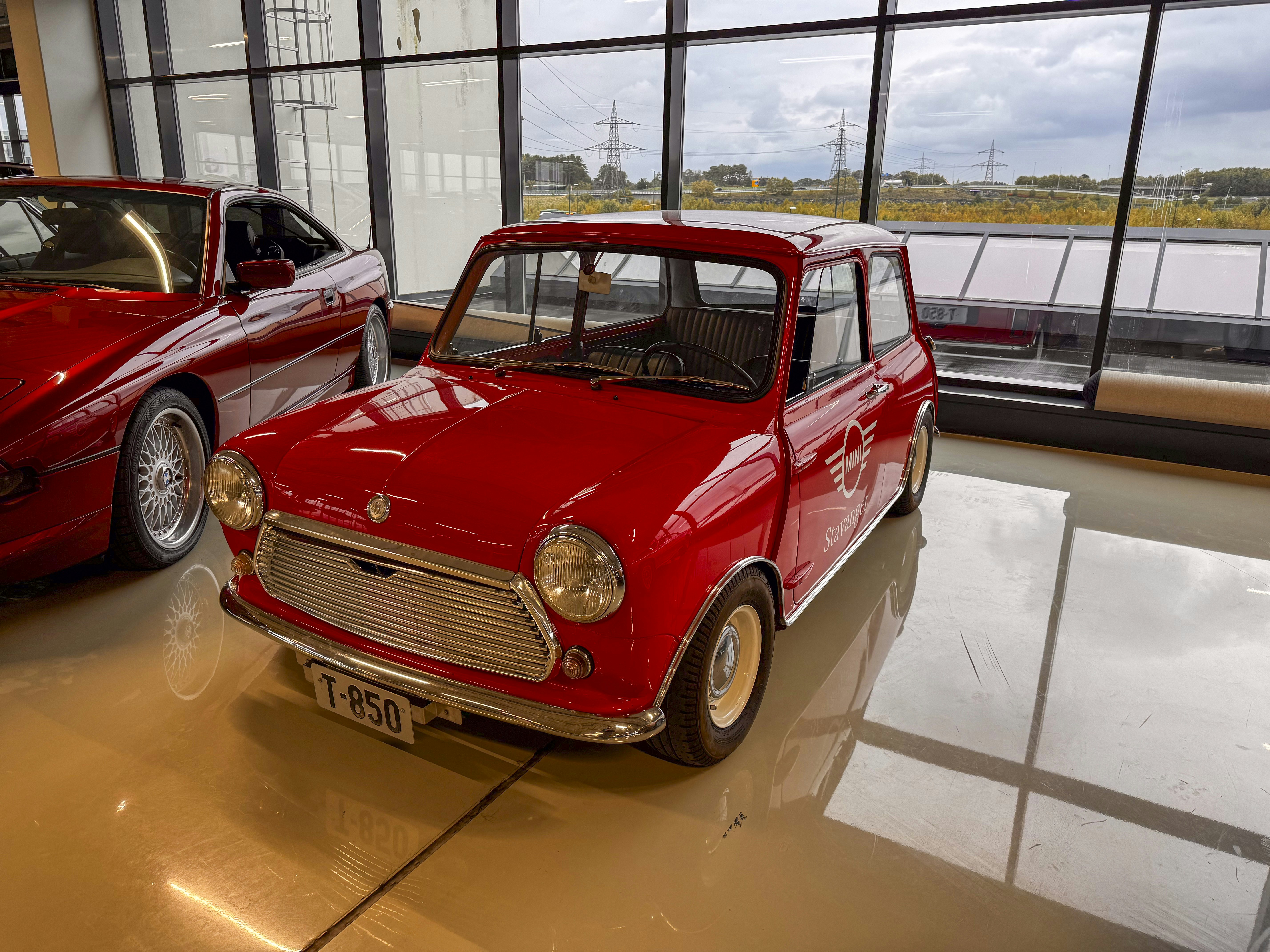Red vintage Mini Cooper on a polished showroom floor