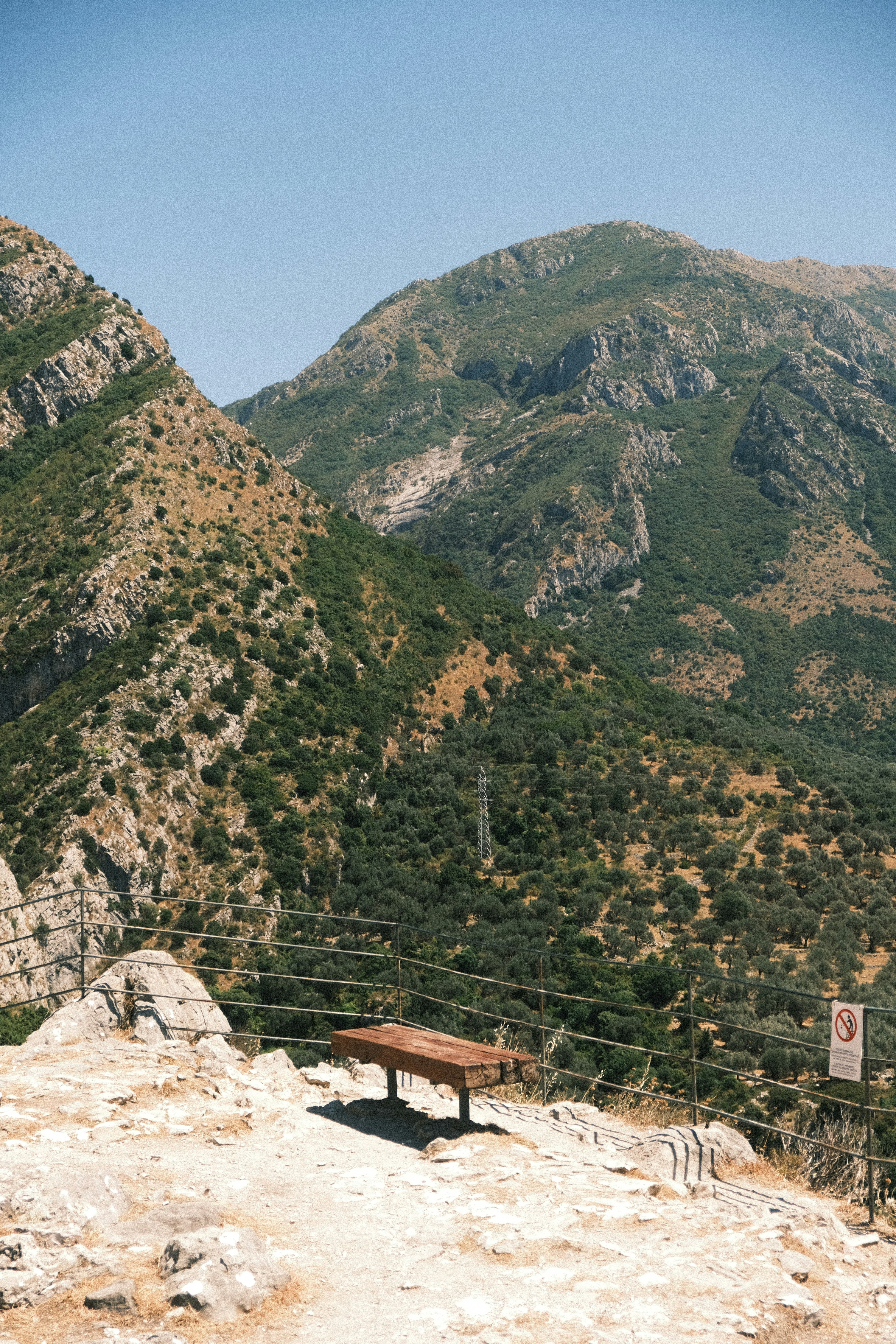 Mountaintop View with Weathered Bench Overlooking a Valley Rim