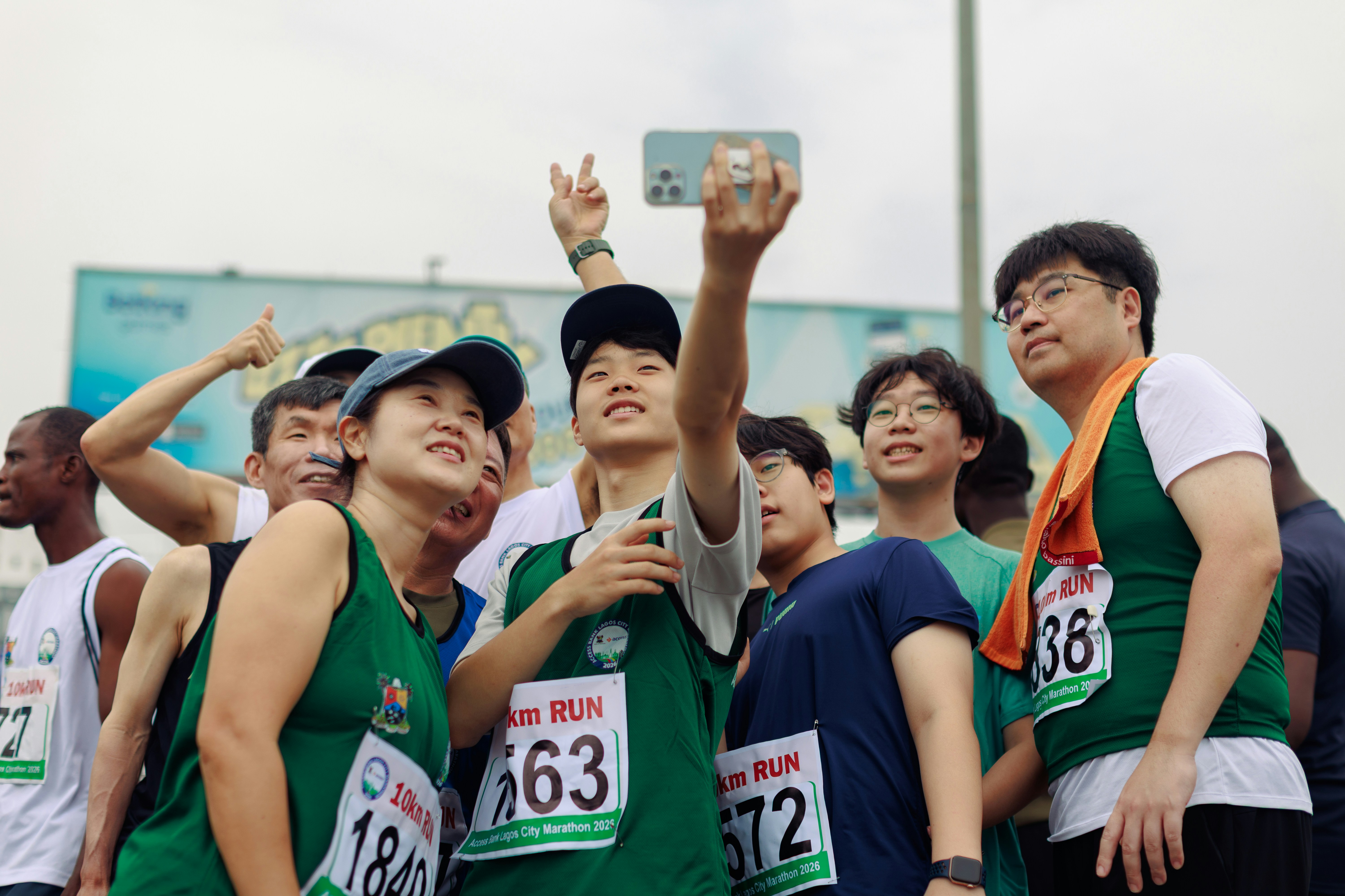Group Selfie Rally: Faces and Focus Amid a Marathon Start
