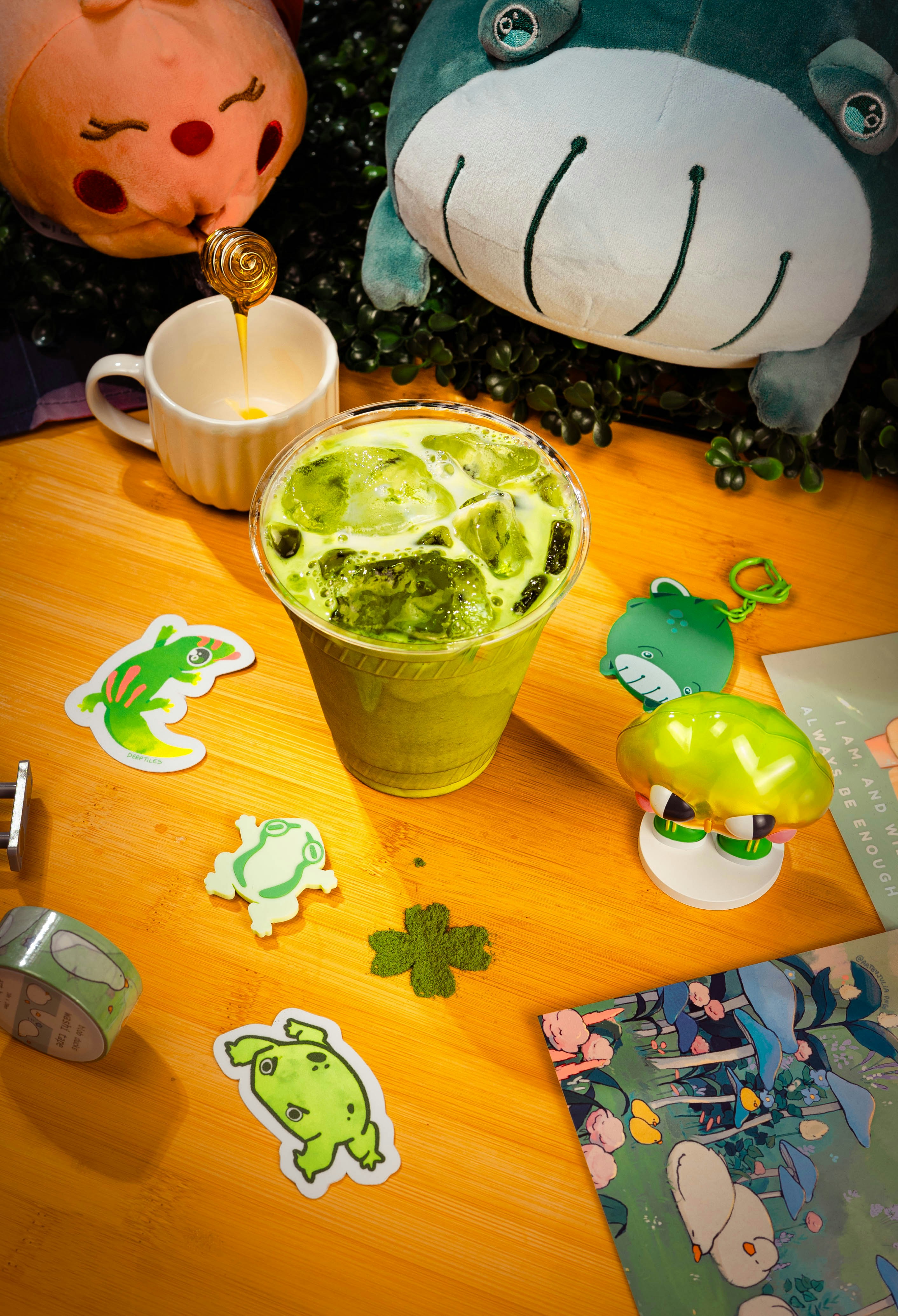 Green Iced Wonder: A Cup and Cute Plush World on a Wooden Stage