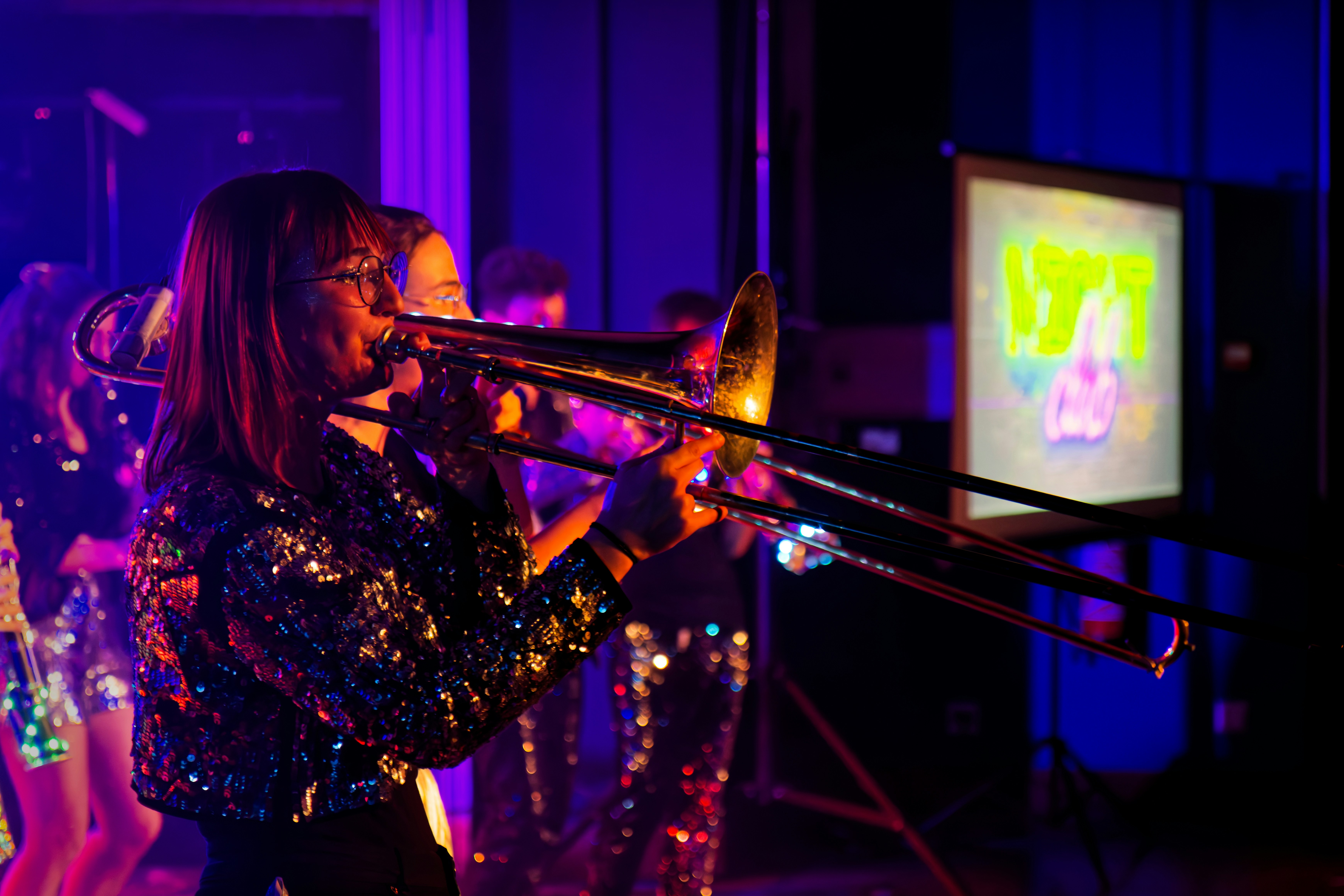 Mujer tocando el trombón con una chaqueta de lentejuelas foto – Imagen ...