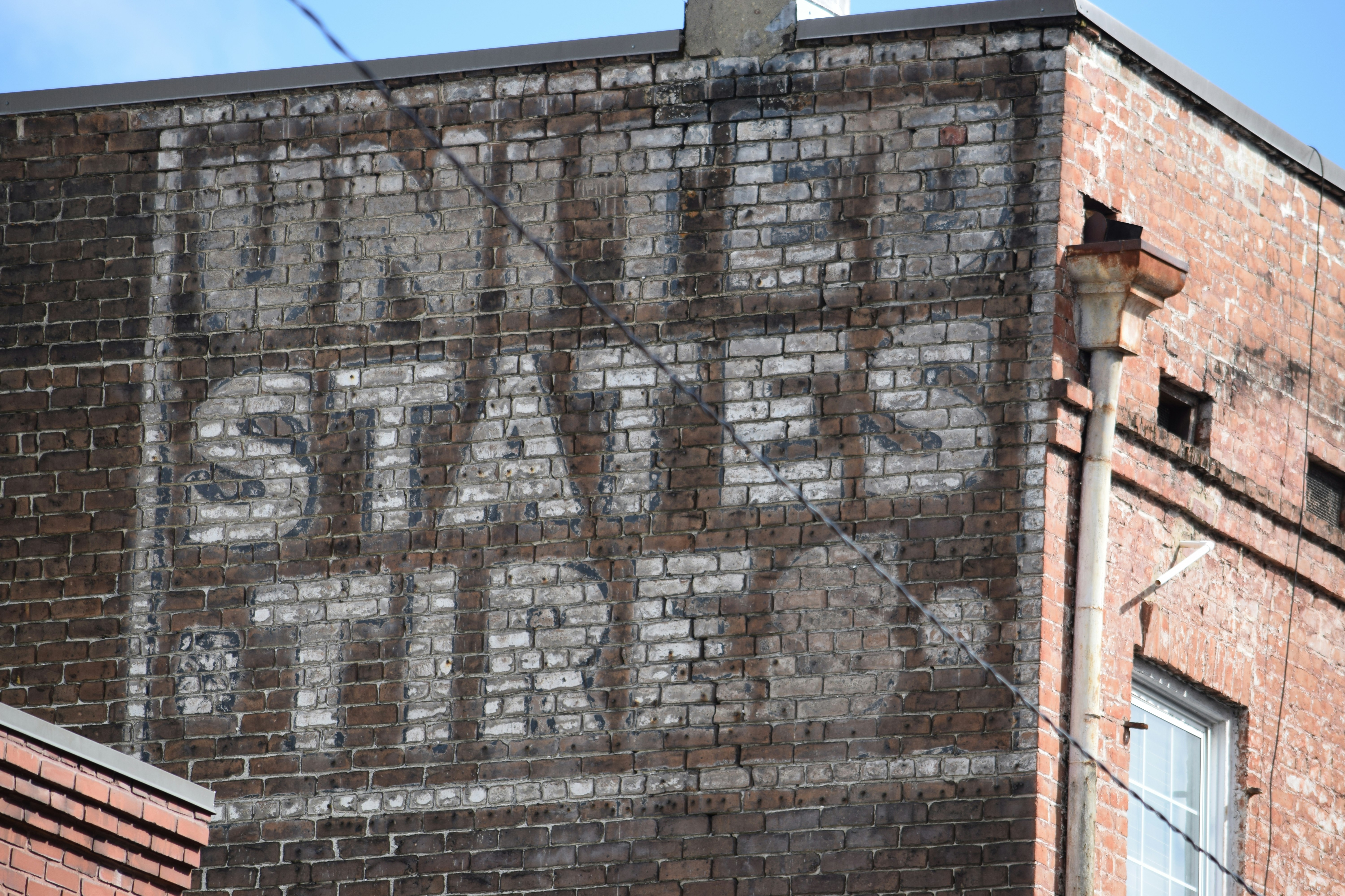 Weathered Prominence: Faded Monopoly of a Brick Facade
