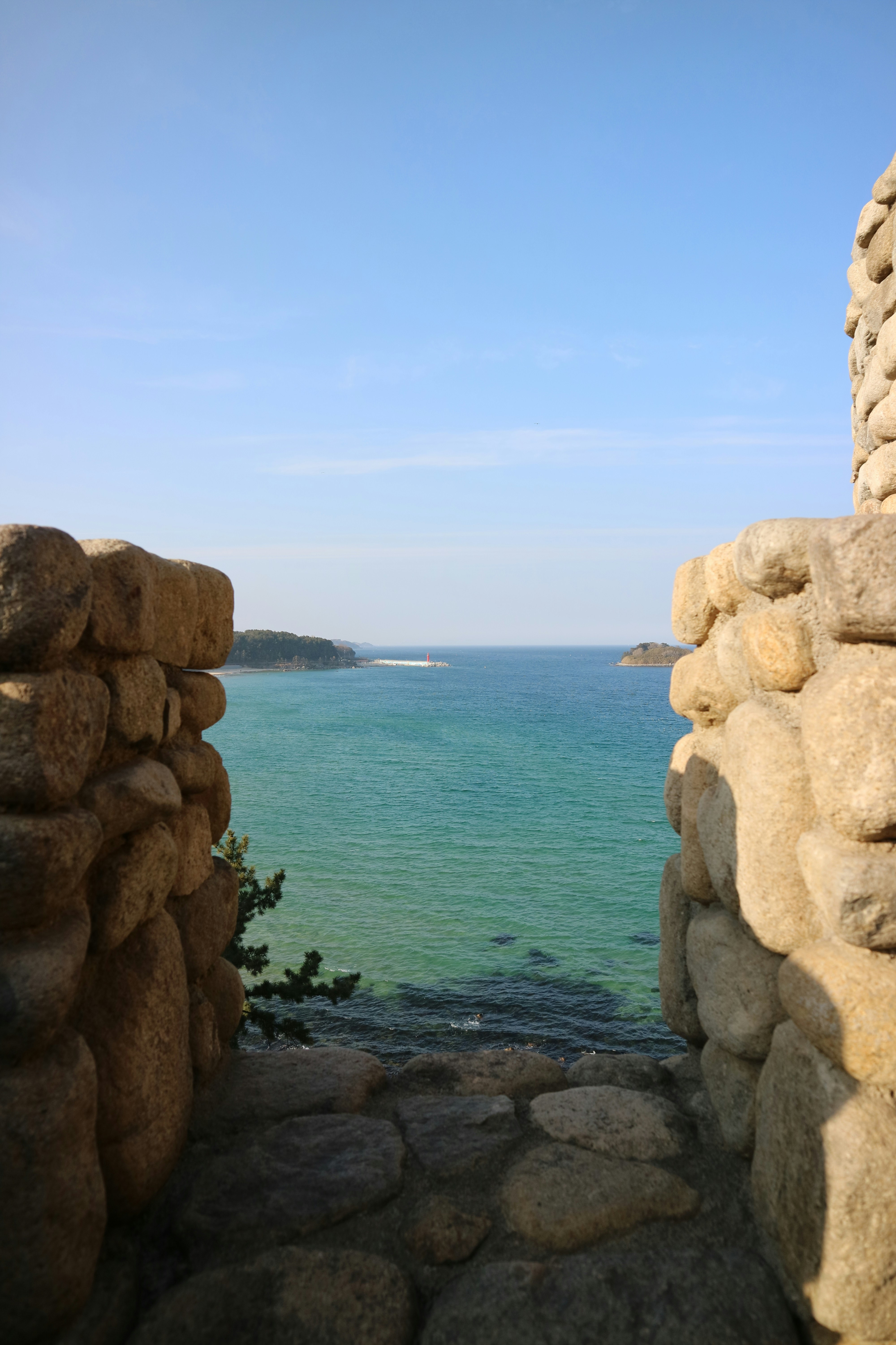 Sea Gate: View Through a Stone Archway to Calm Blue Waters