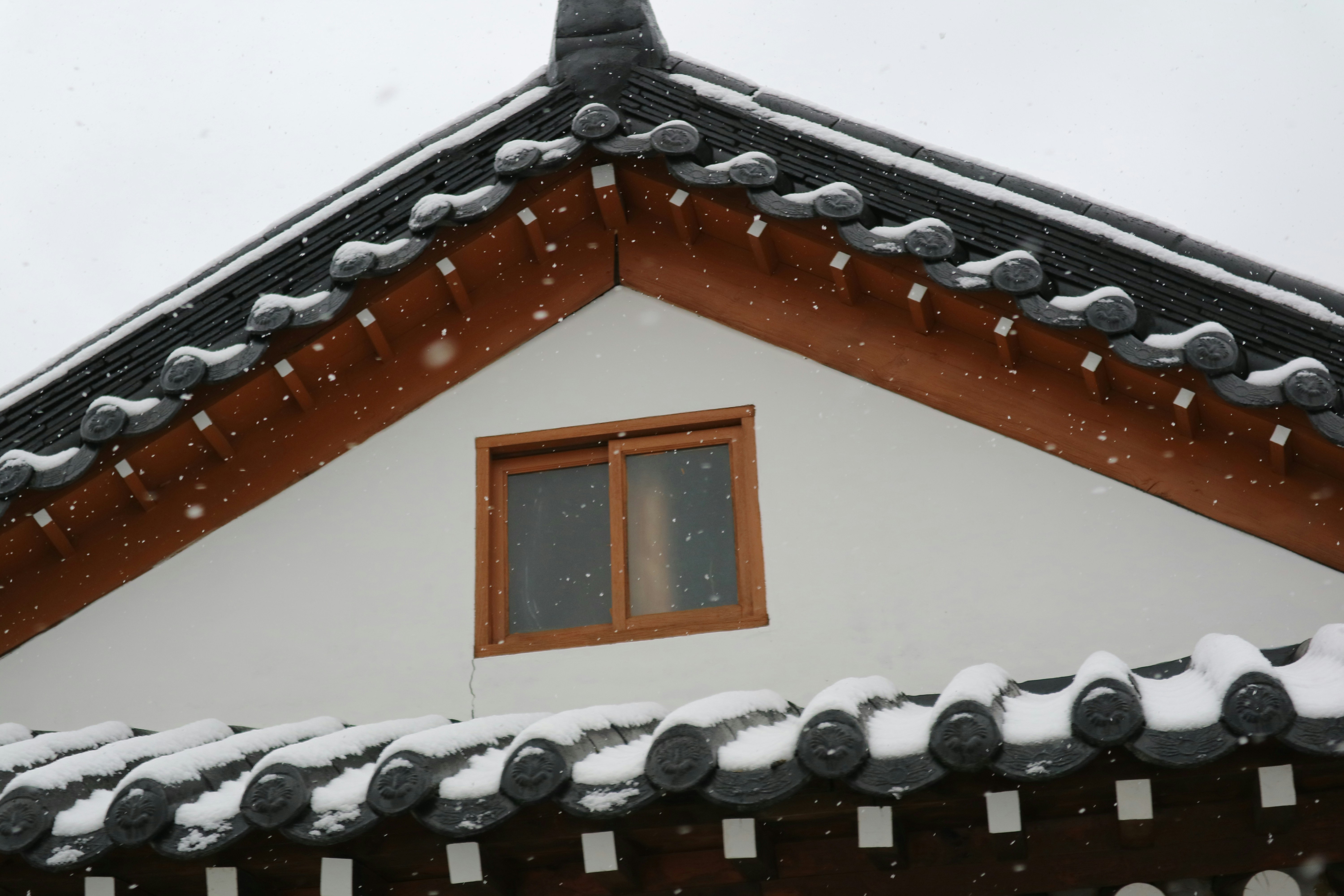 Snow-Laced Roofline under a Quiet Window