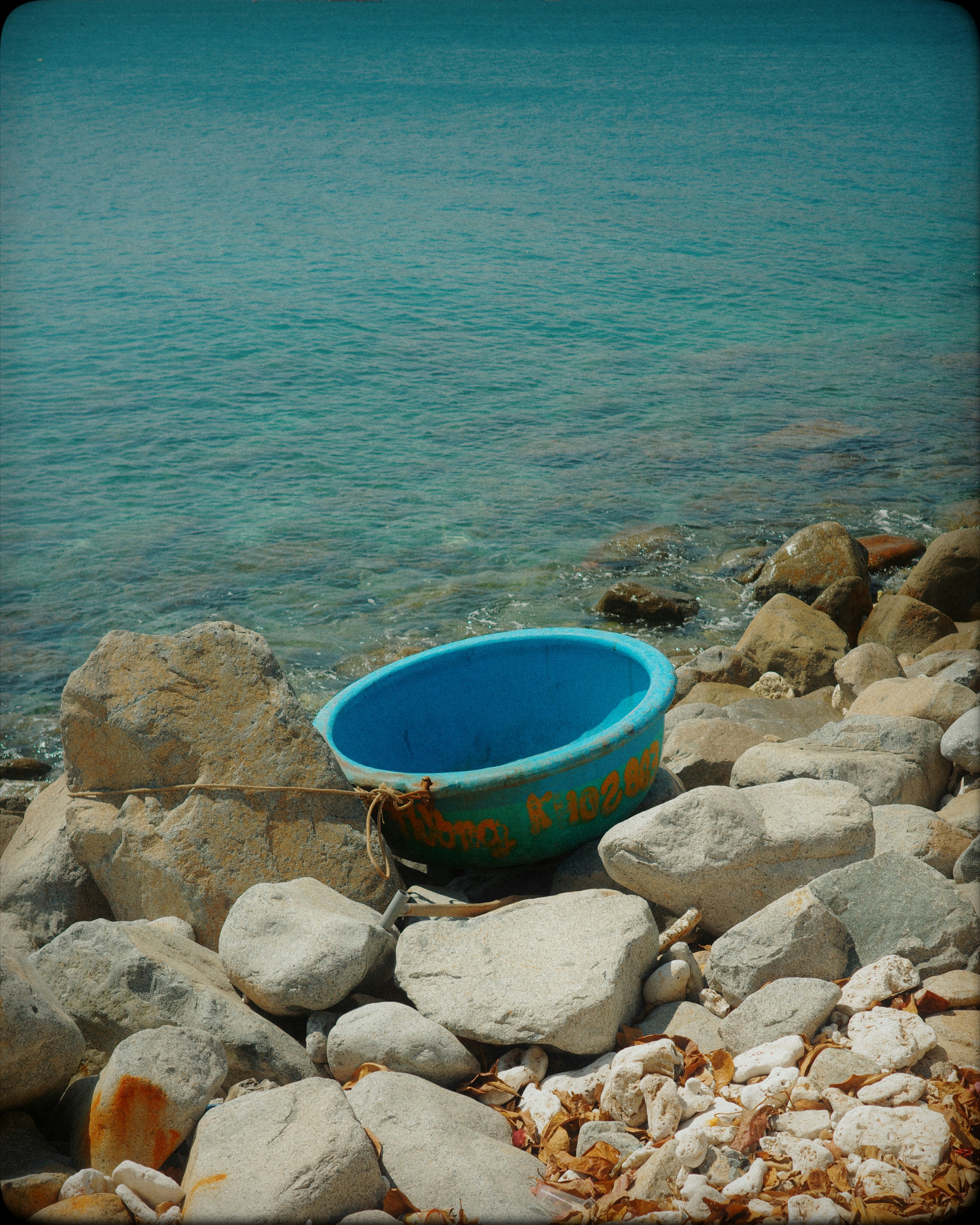 Blue Basin on the Shore: A Cerulean Bowl Nestled among Quiet Stones