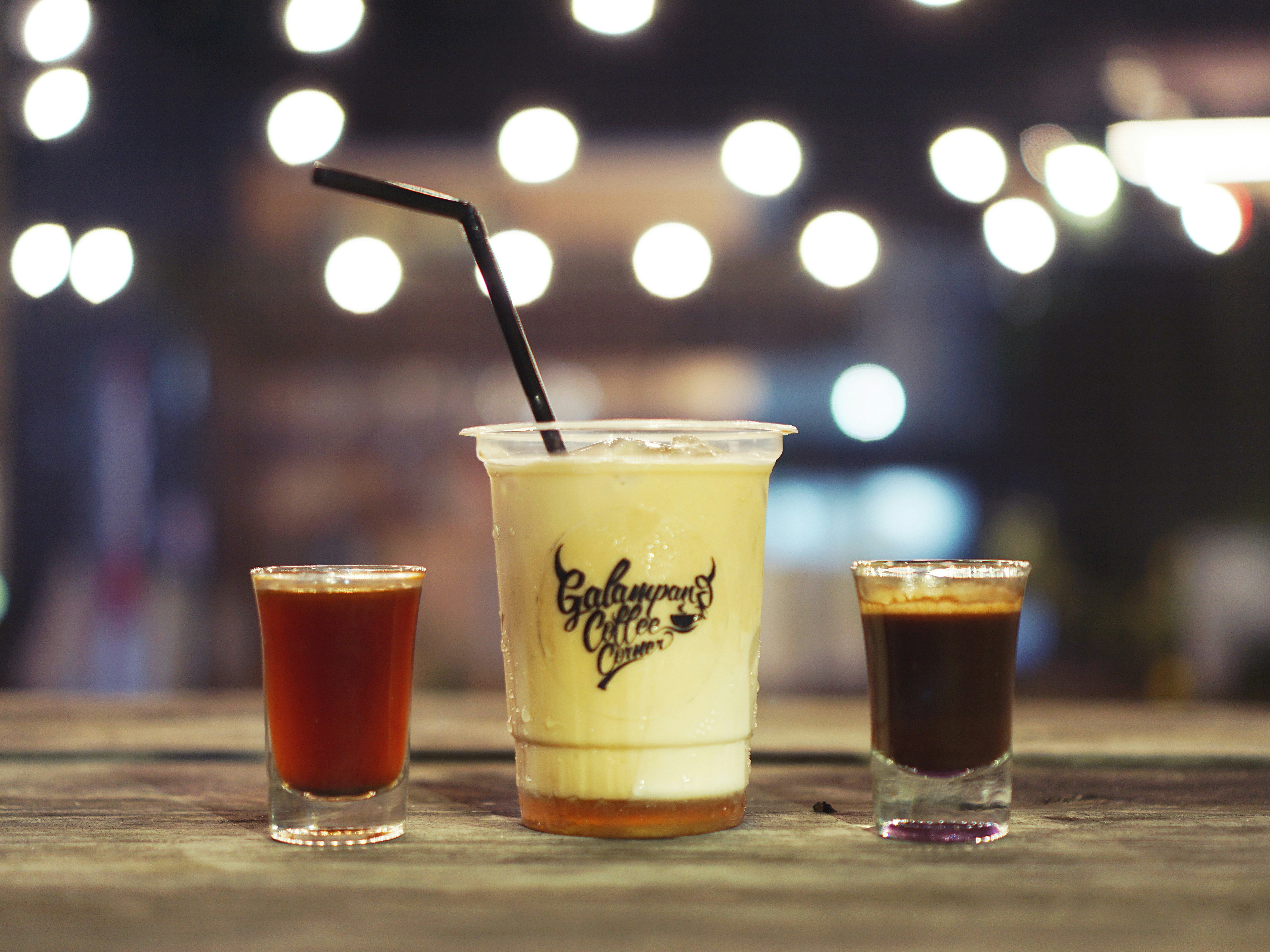 Three Shots on a Weathered Counter Under Warm Bistro Lights