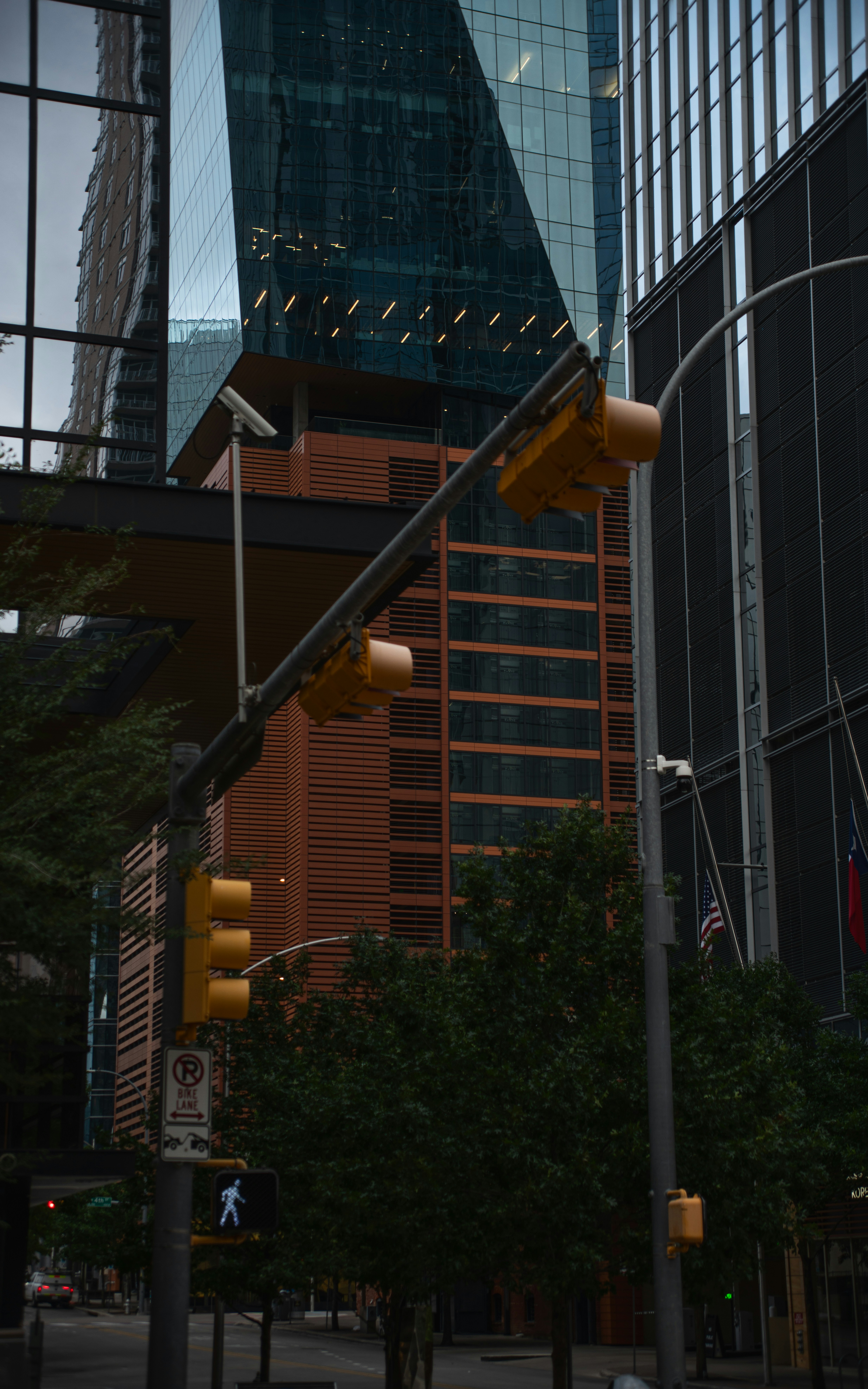 Traffic Signals Against Modern Glass: A Narrow Urban Corridor