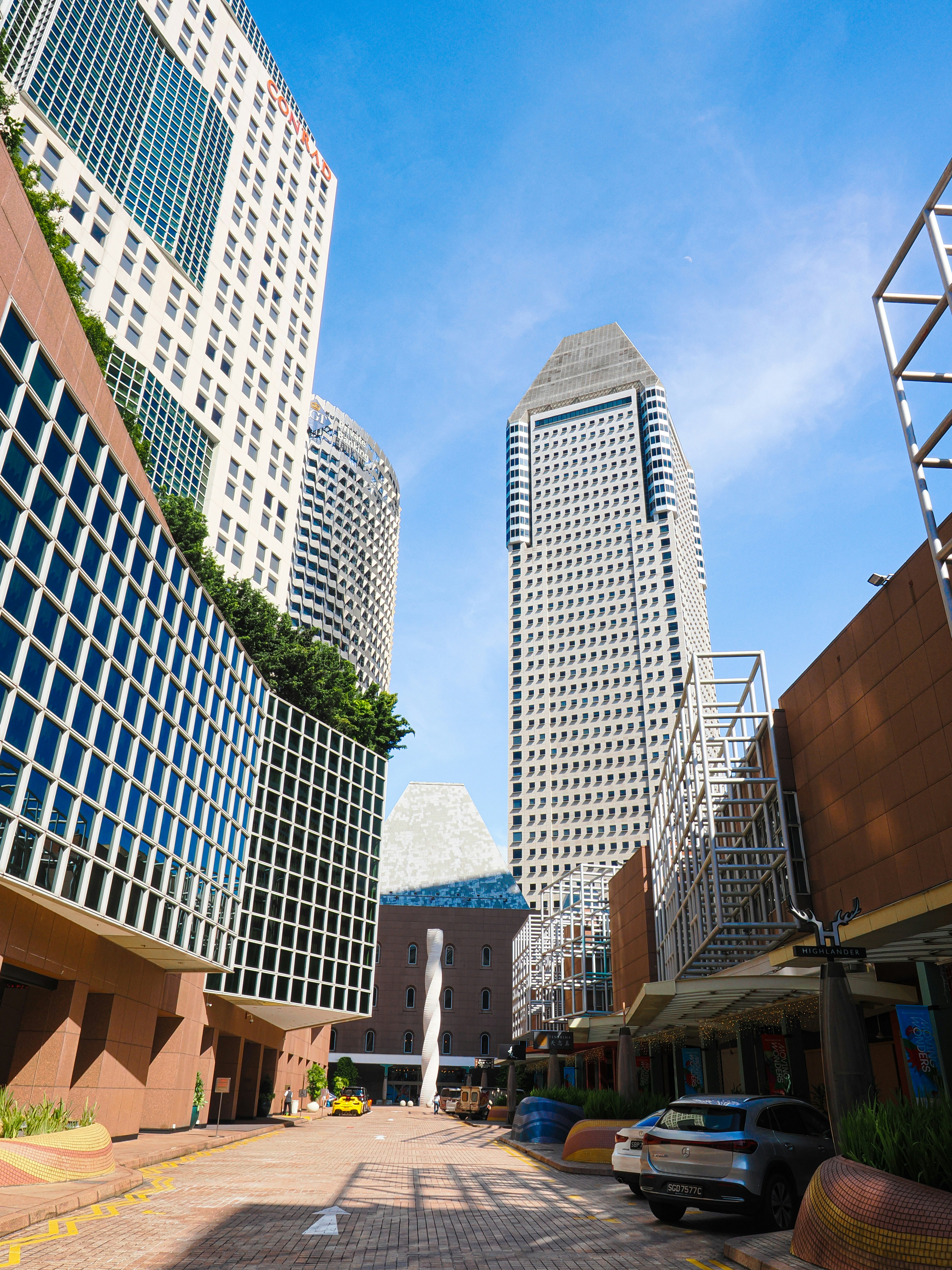 Urban Canyon: Towering Spires and Sky Beneath a Narrow Street