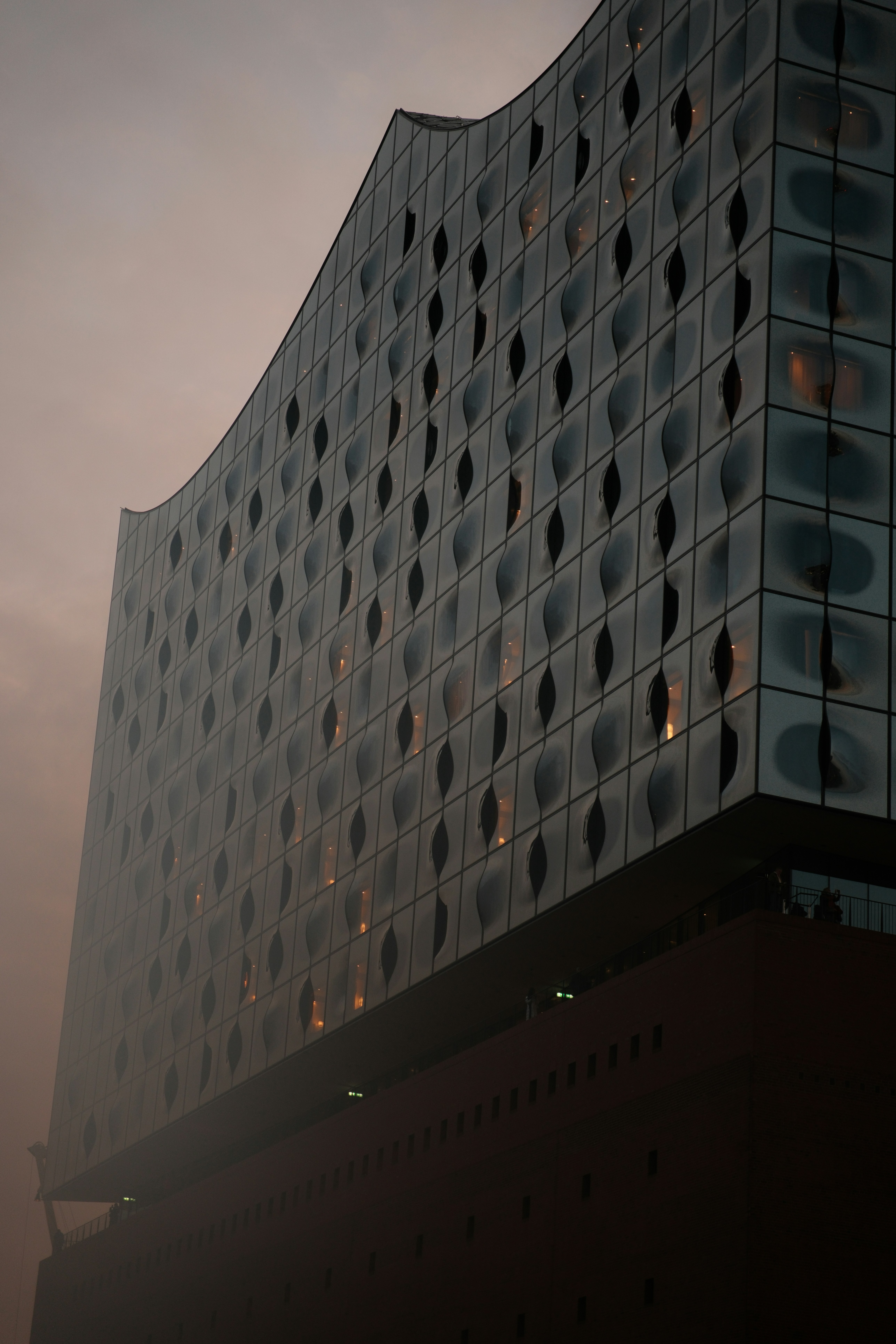 Curved Facade, Dusk Light: A Modern Glass Mosaic In Perspective