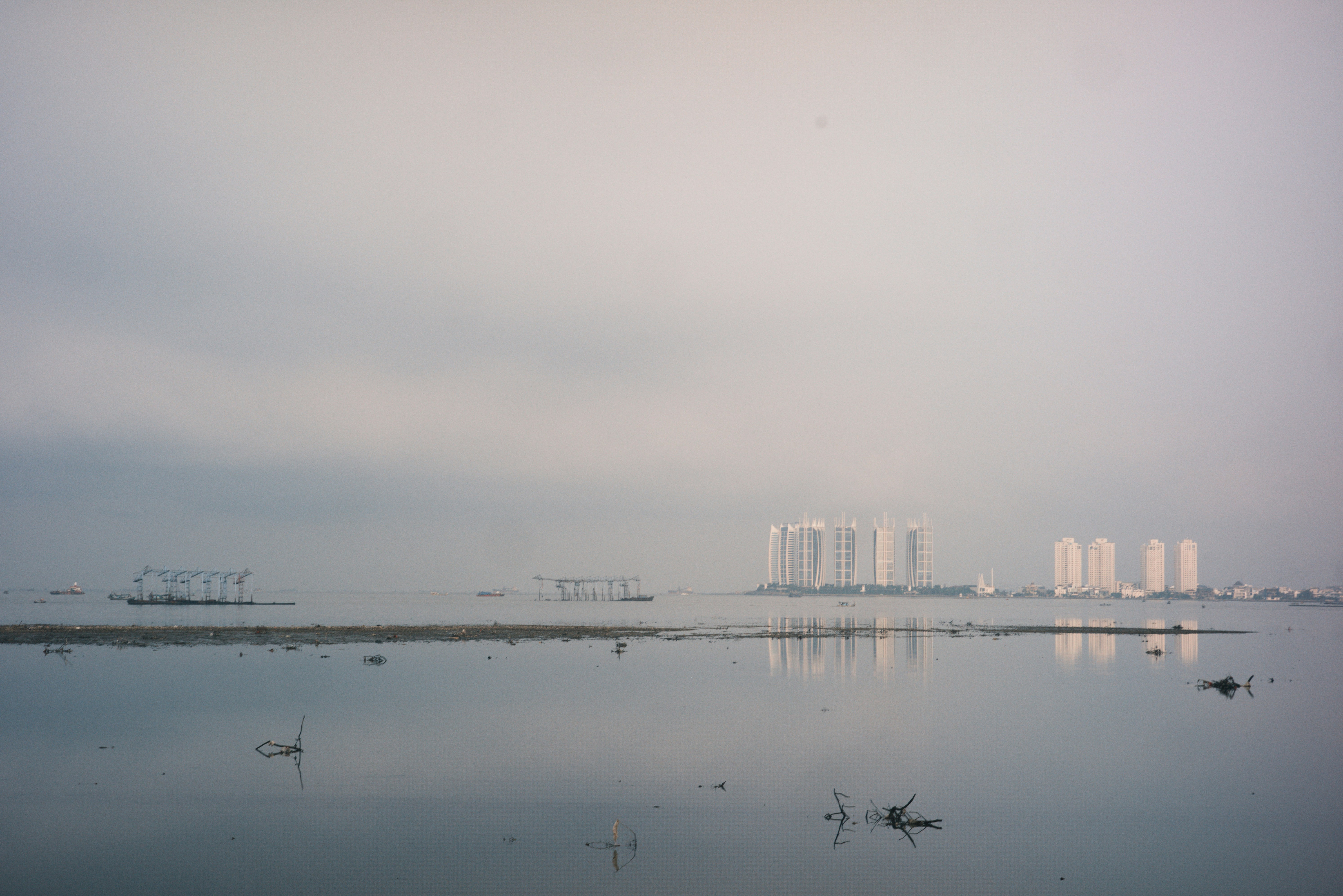 Shoreline Silhouettes: Distant Towers on a Quiet Tidal Plain
