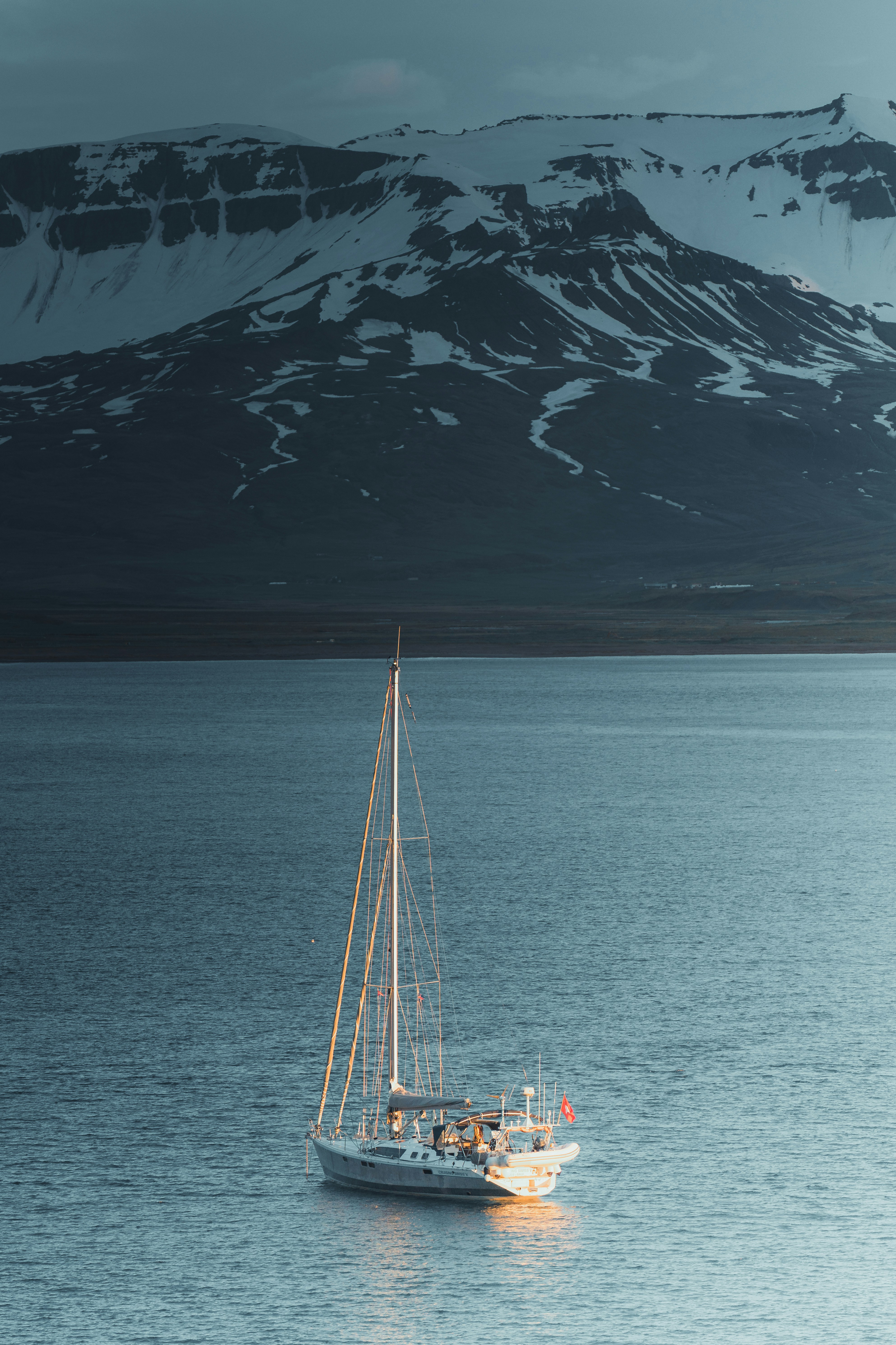 Sailing Quietly Under a Snow‑Dusted Ridge