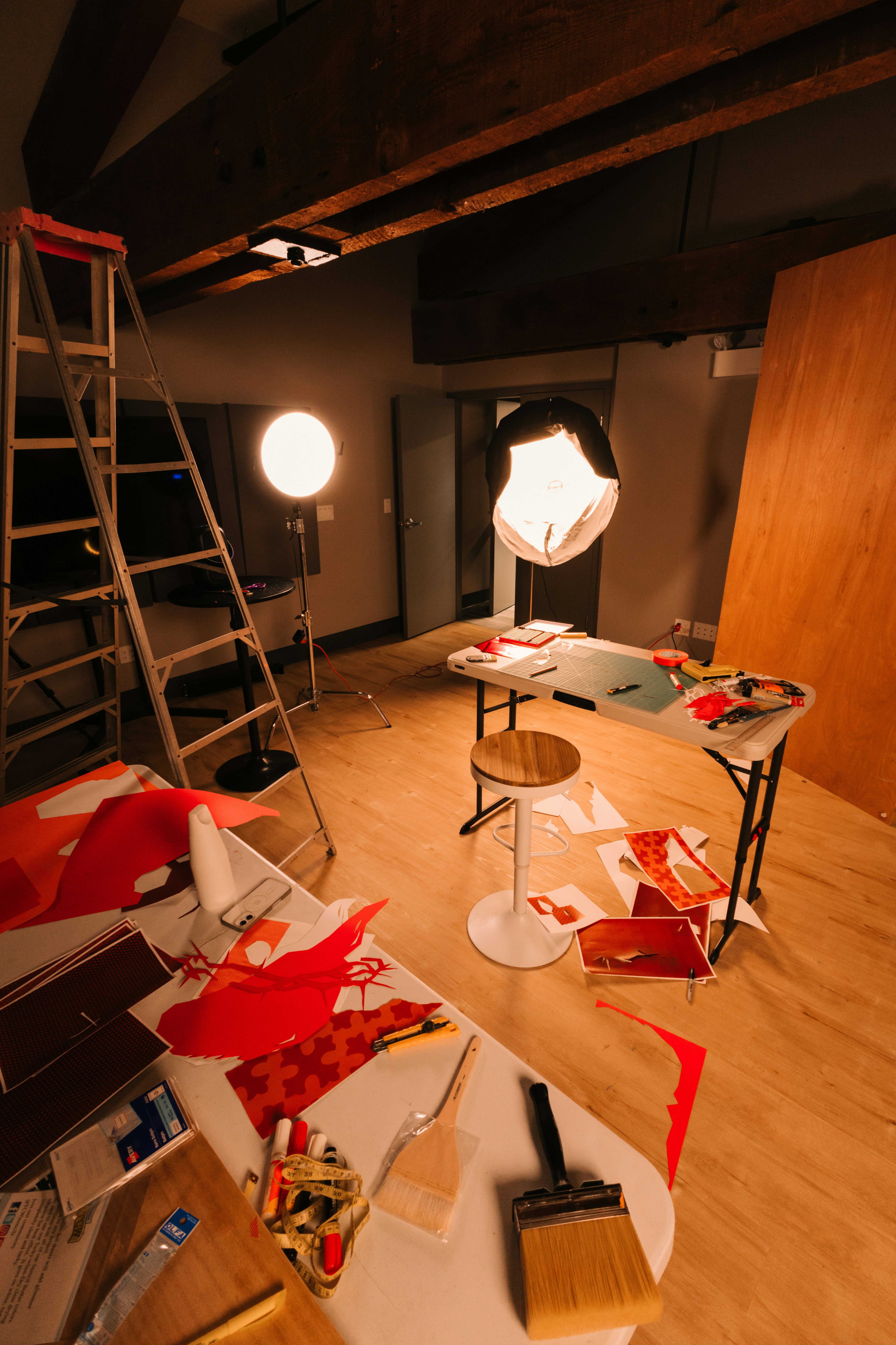 Studio in Disarray: Paint, Light, and Tools in a Creative Workspace
