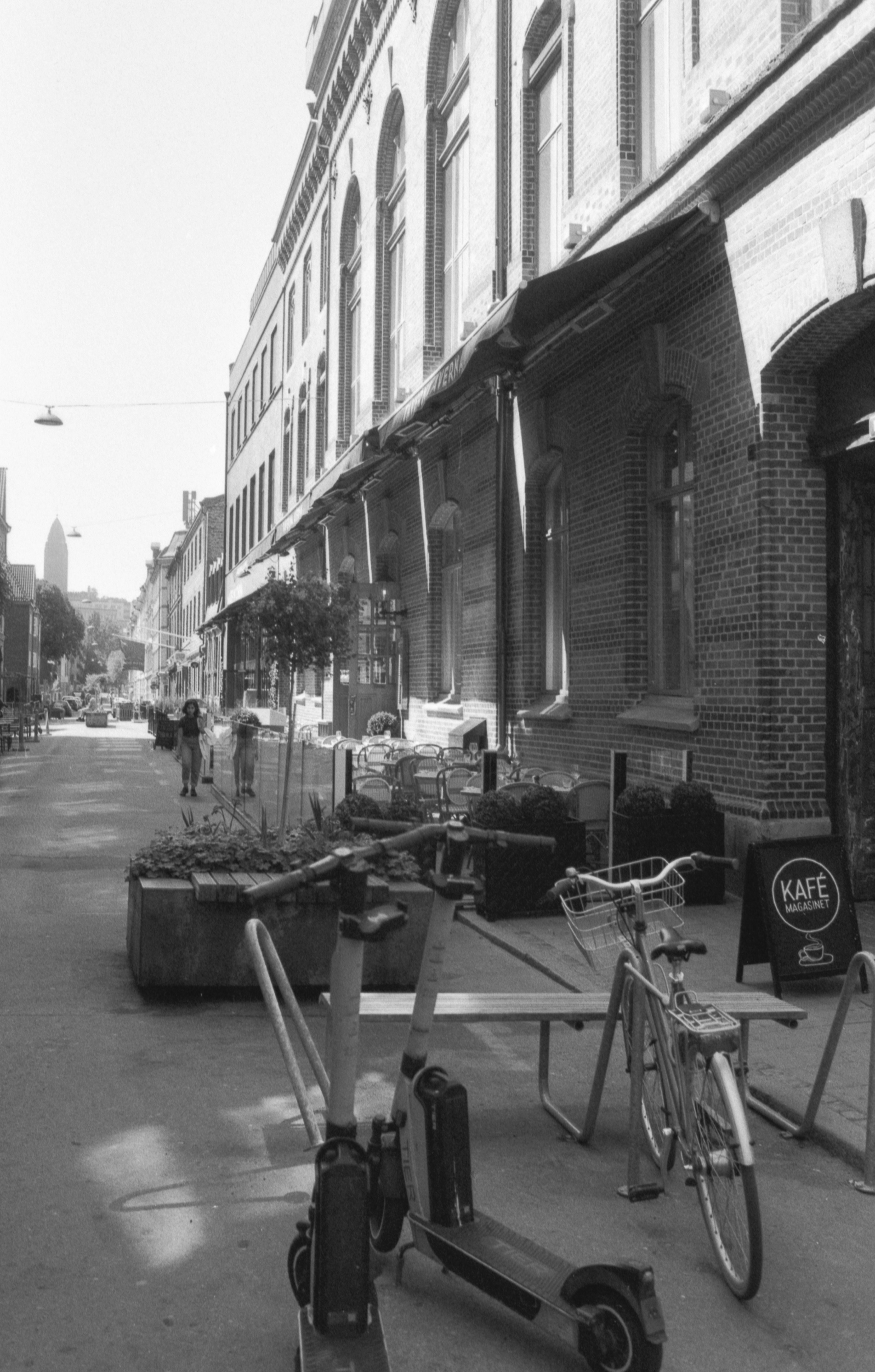Cobbled Street by a Quiet Brick Facade