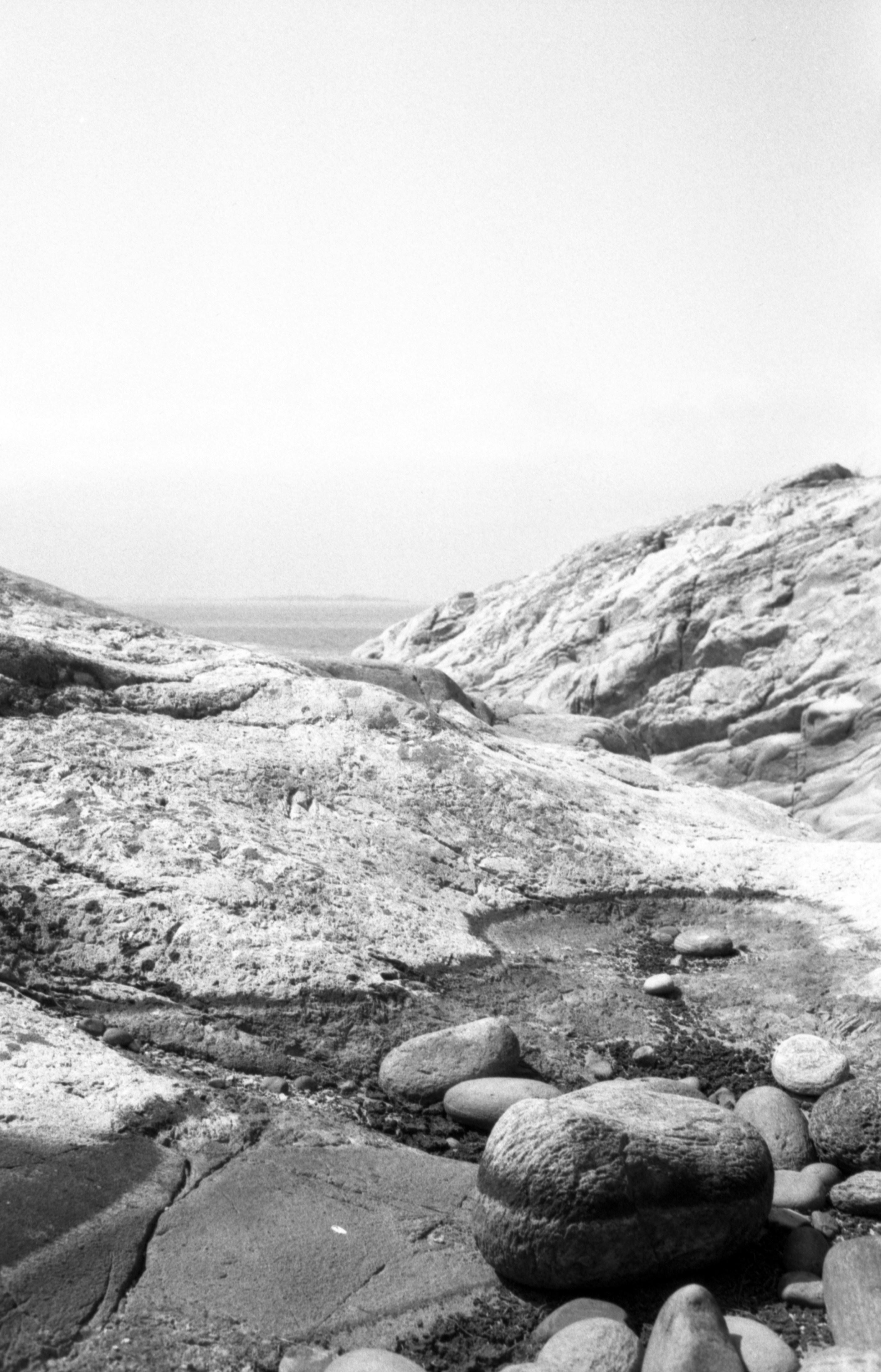 Rocky terrain with scattered boulders and ocean view