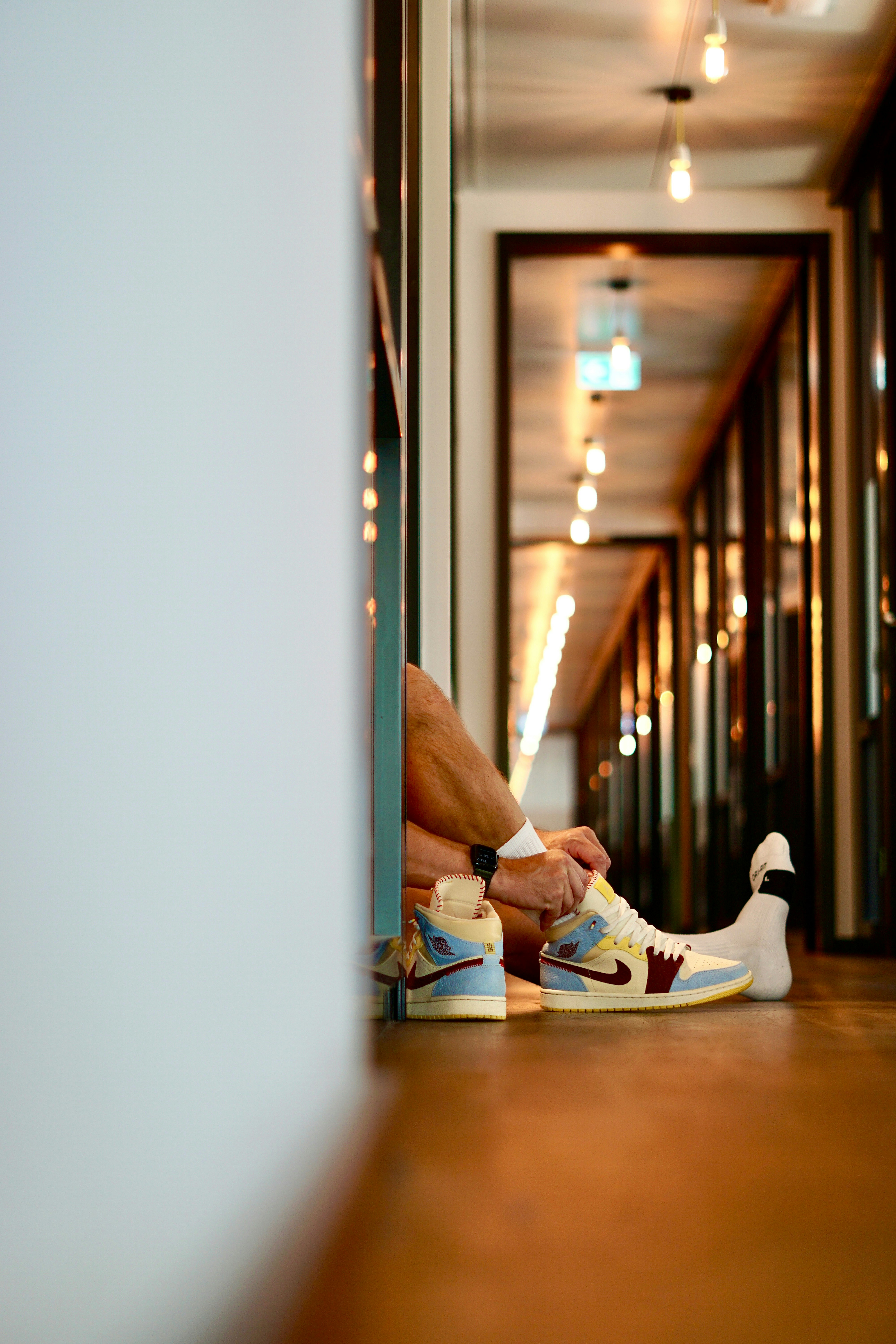 Sneakered Resolve in a Studio Corridor