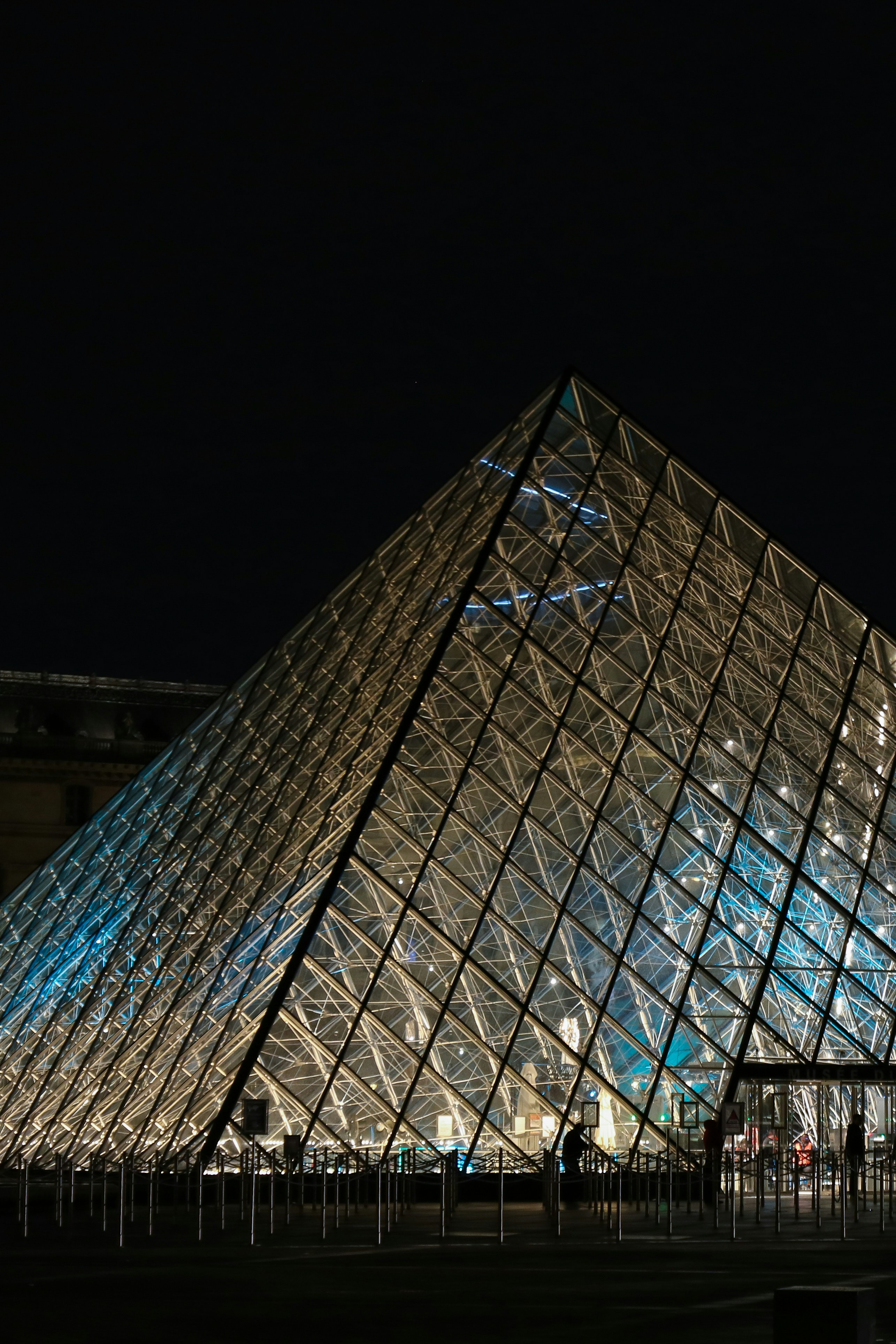 Glazed Geometry at Night: The Pyramid Illuminates the Square
