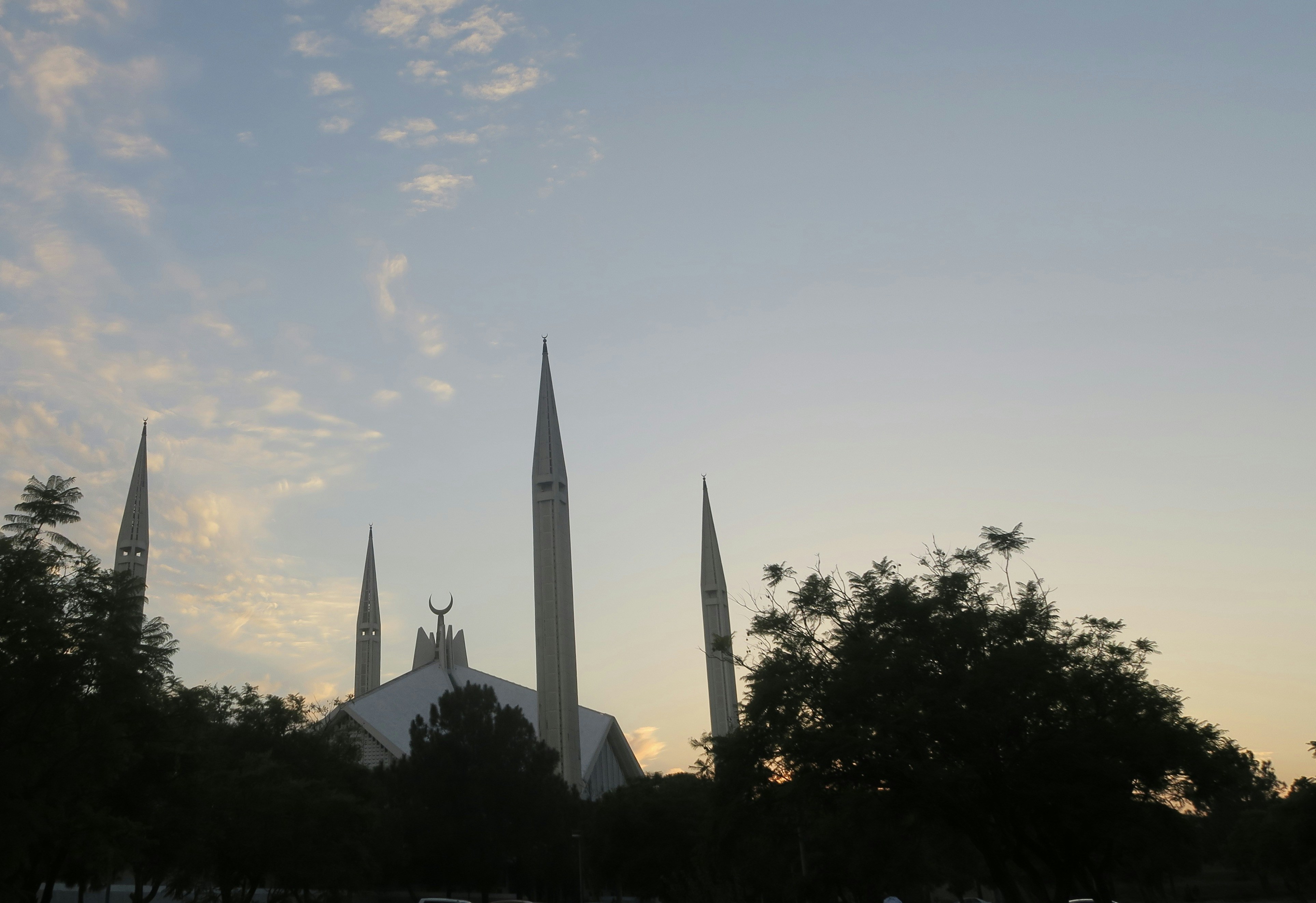 Silhouetted Minarets Against a Pale Sunrise