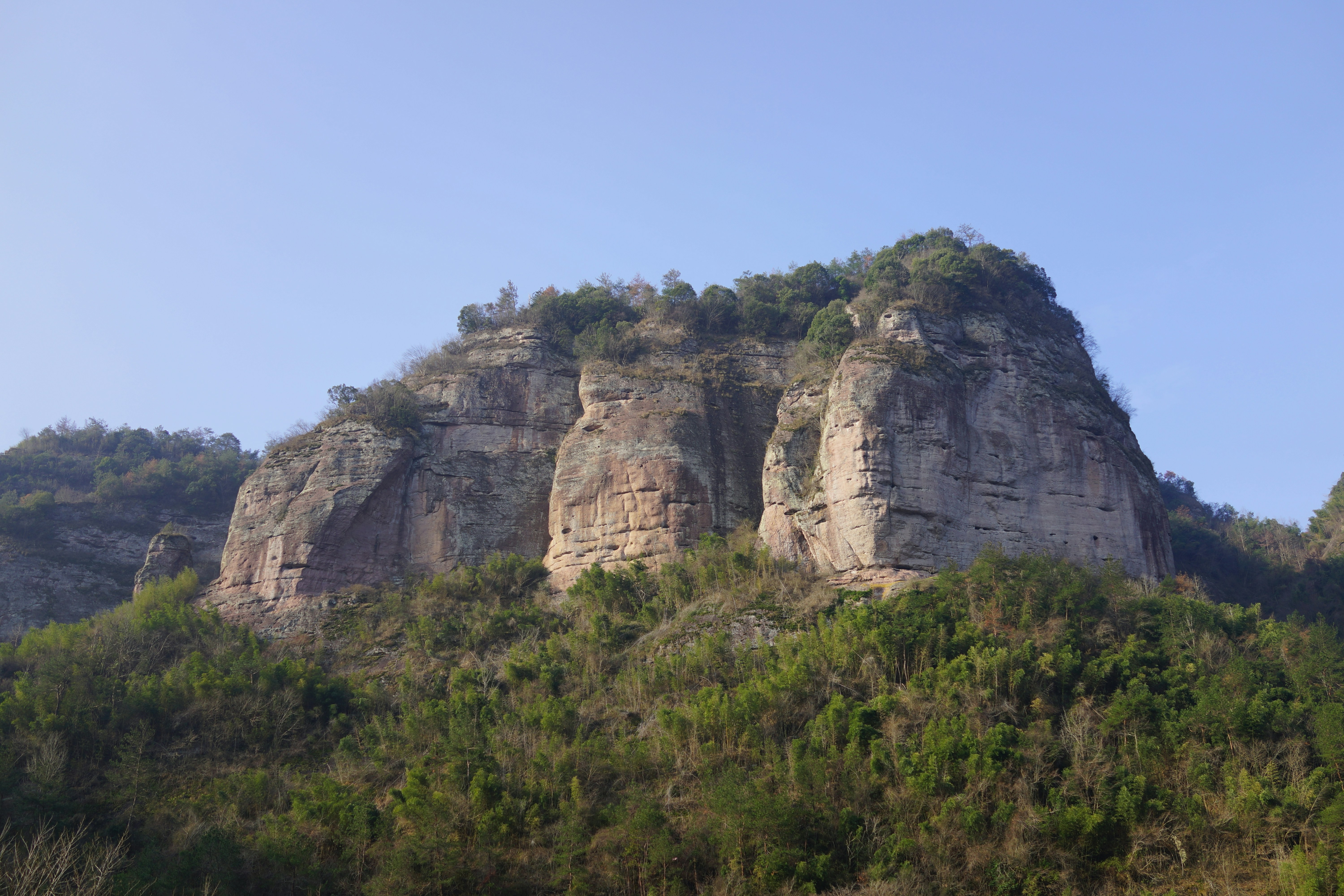 Stone Sentinel Rises Above Green Slopes