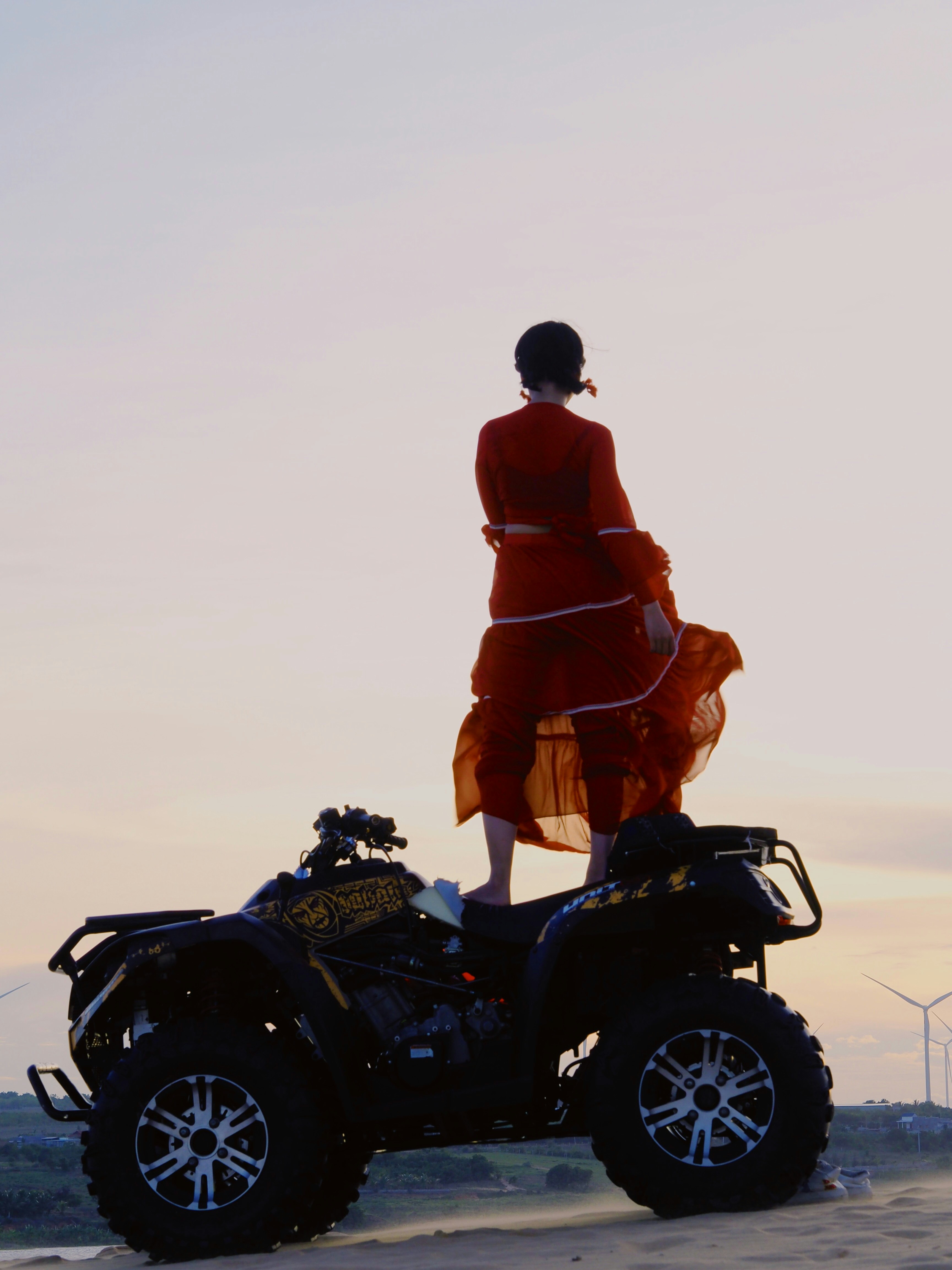 Red Dress on Wheels: A Silhouette at Dusk