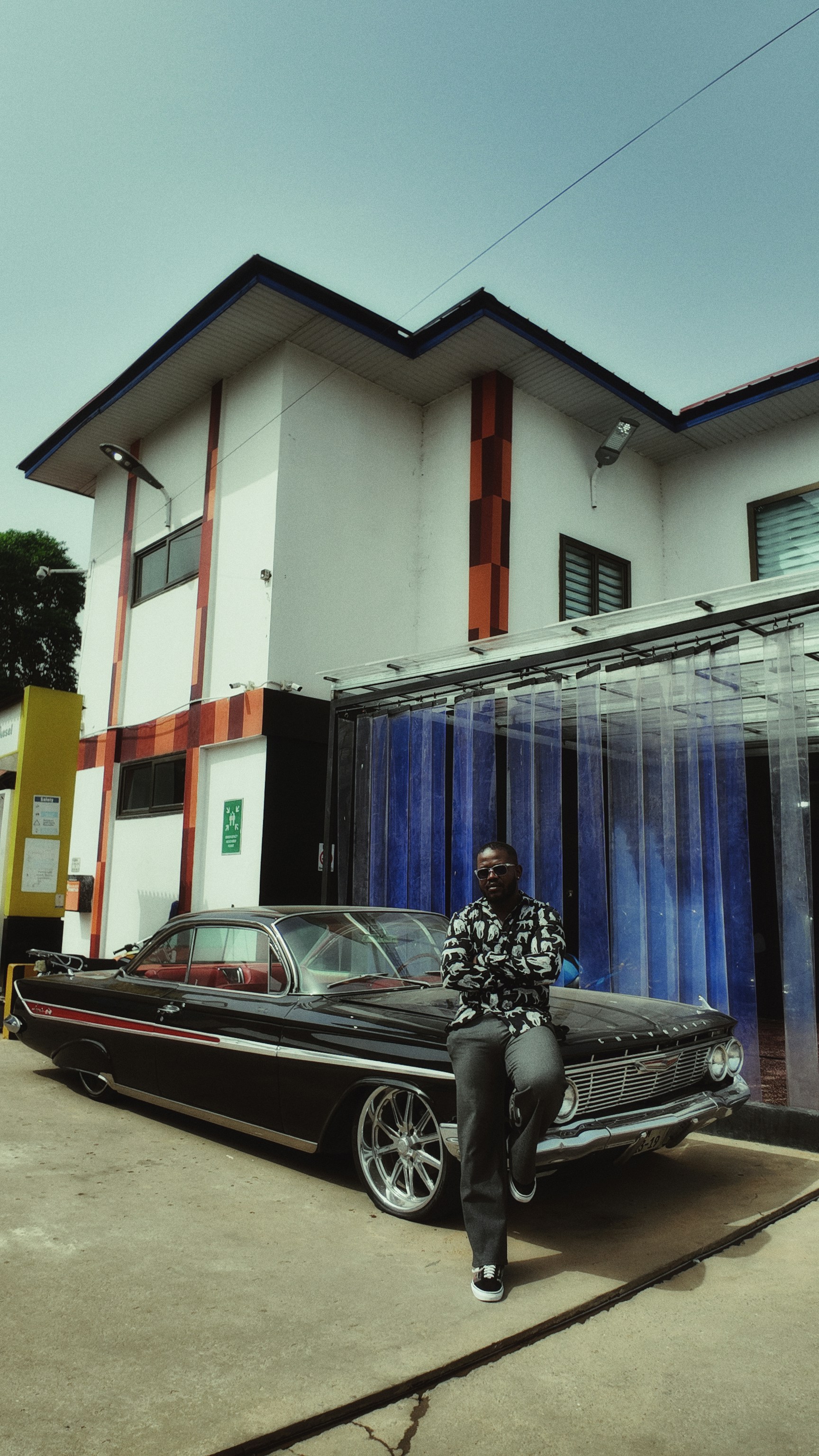 Man leaning on a vintage black car