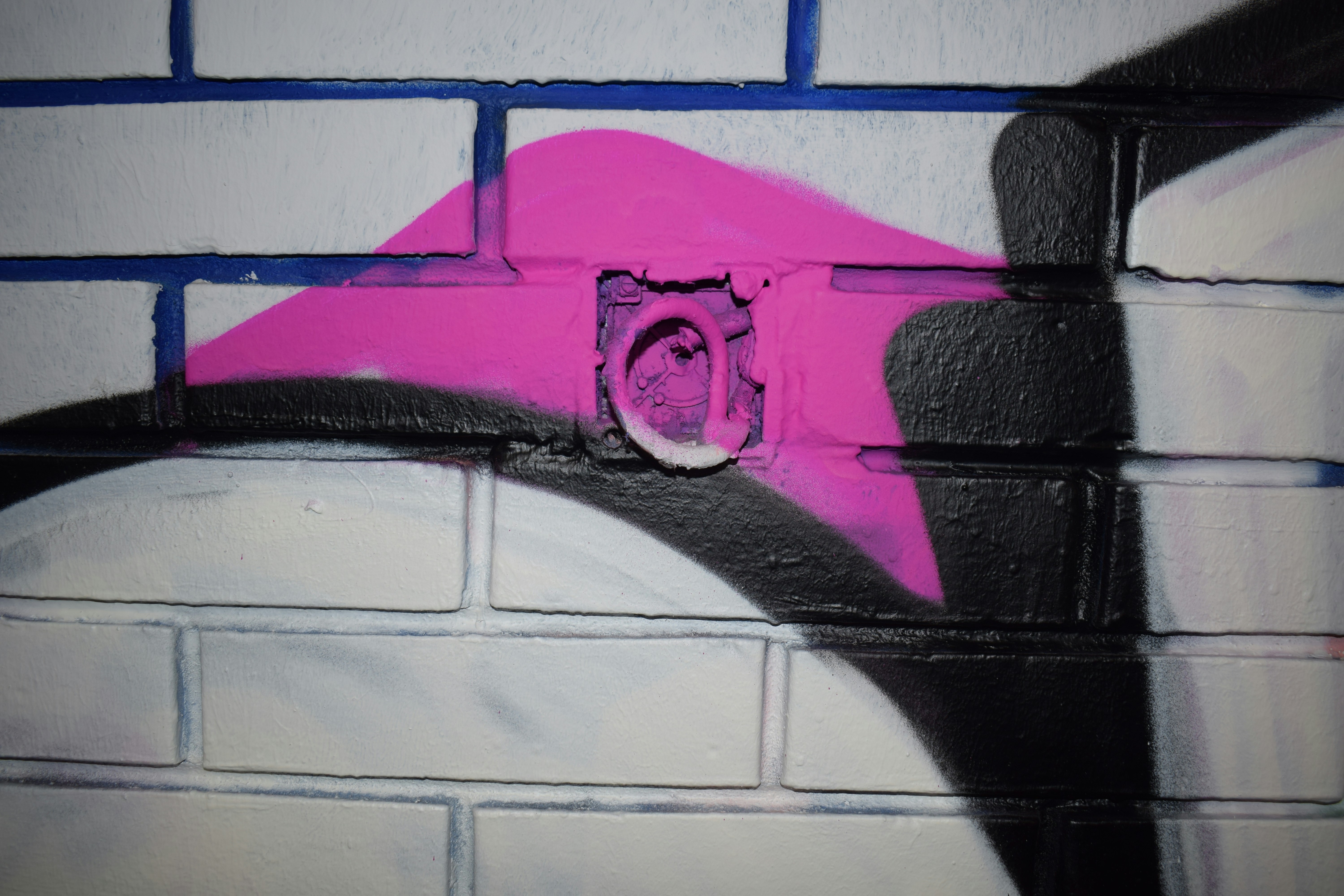 Neon Pink Accents on Brick Graffiti