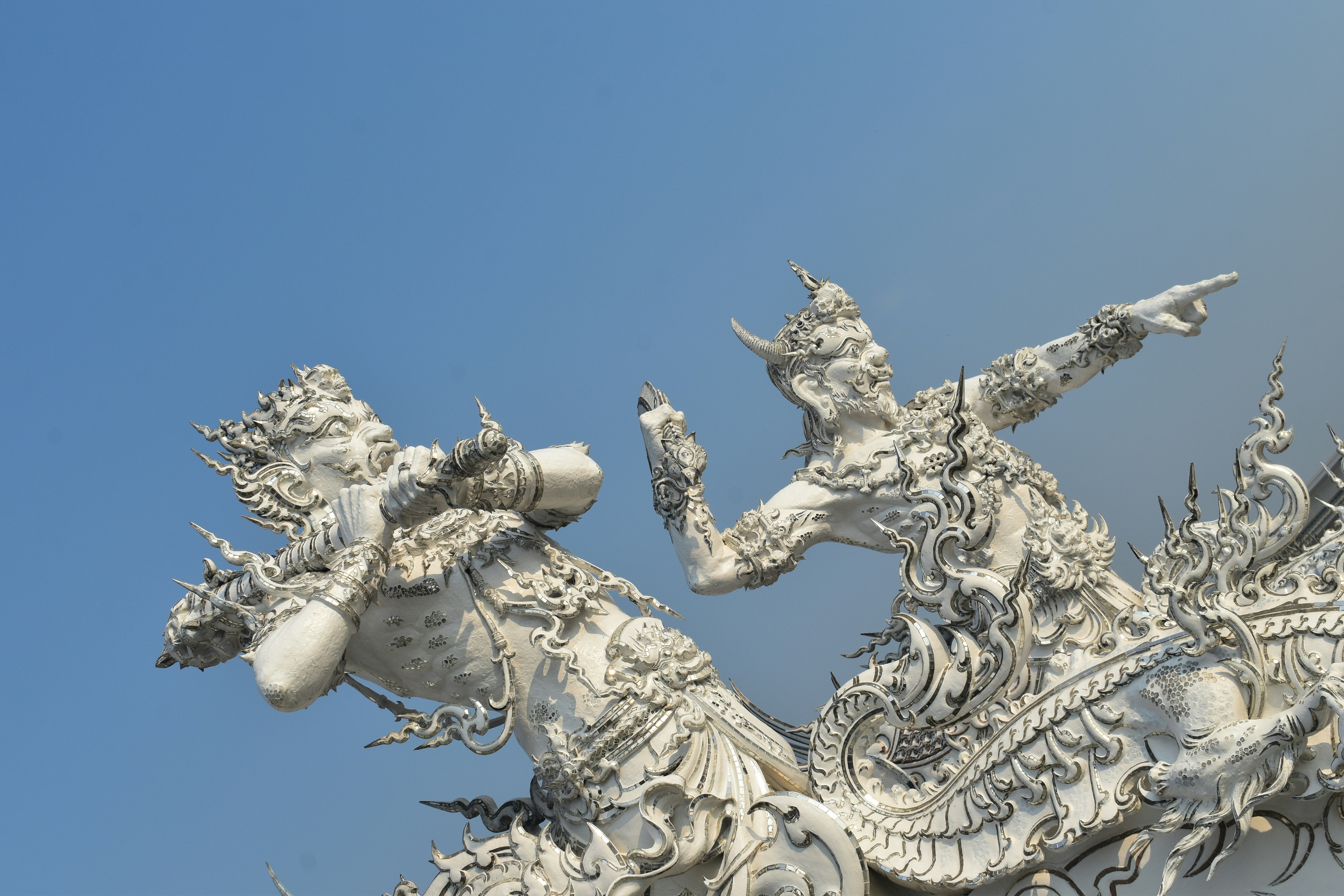 Celestial Guardians in White: A Sky-High Carvingscape
