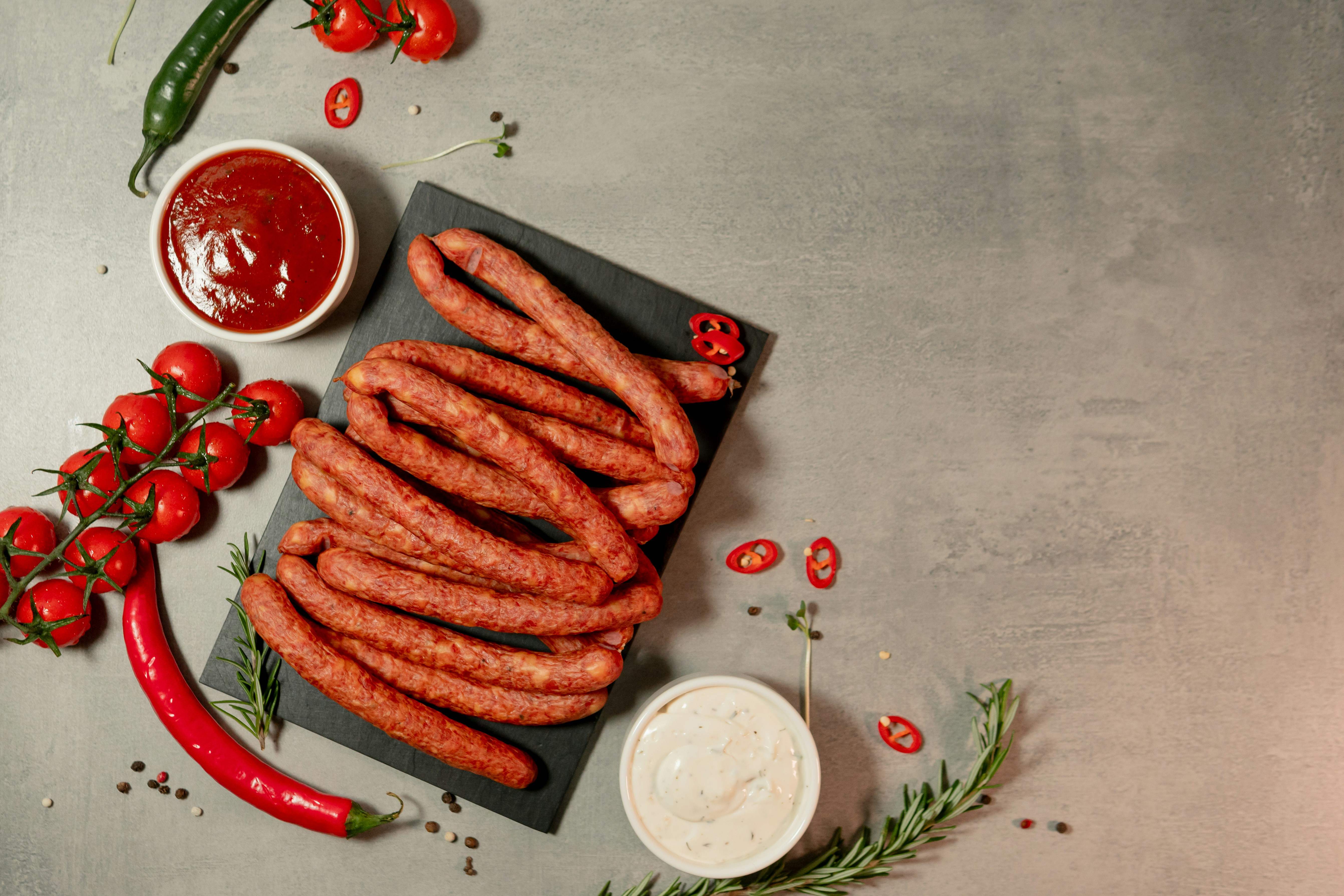 Charred Slices and Cream: A Rustic Plate of Sausages with Dipping Sauces