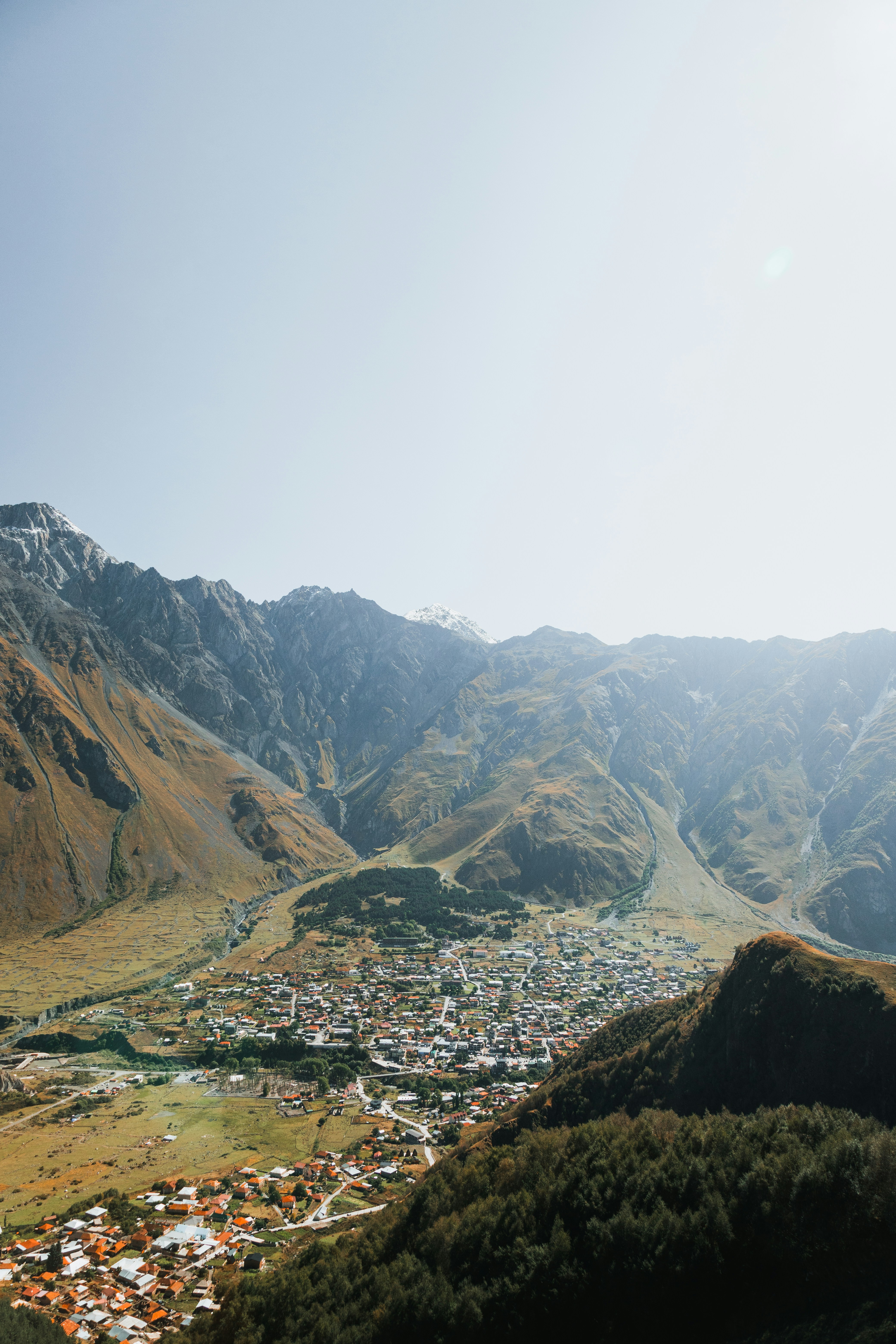Valley village nestled in sunlit Alpine slopes