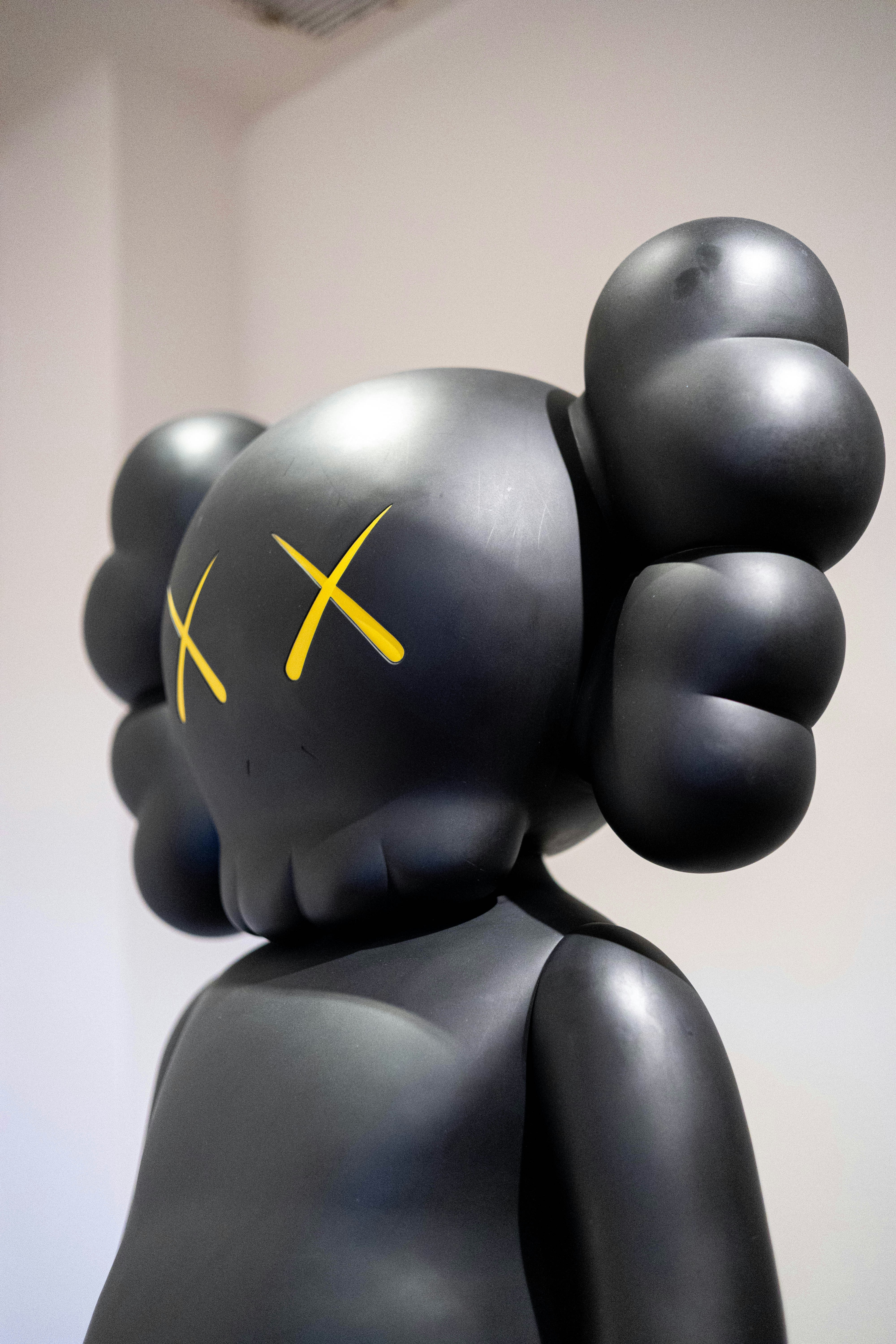 Kaws-inspired sculpture with X-eyed visage in soft studio light