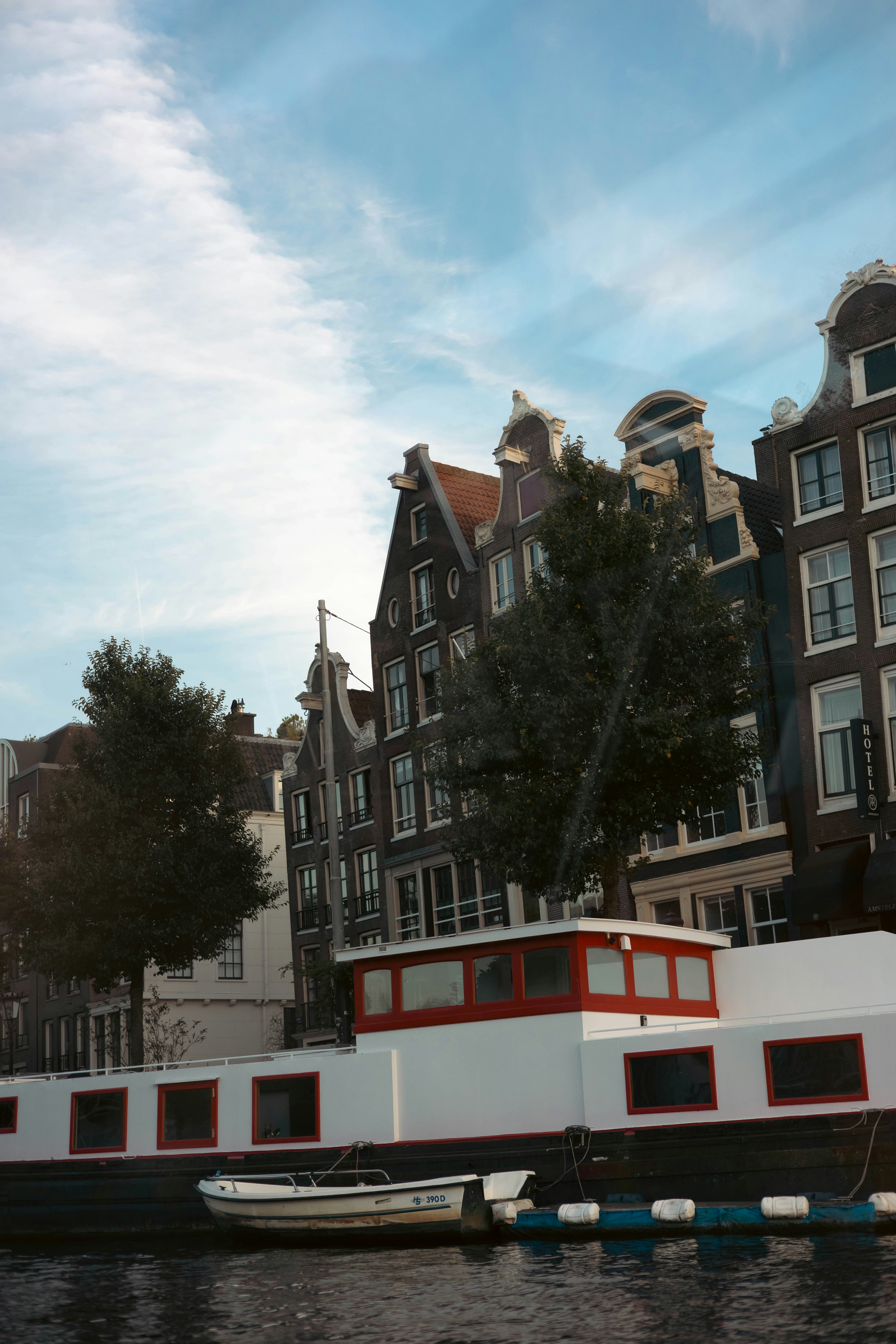 Canalfront Gables at Dusk: A Winged Boat and City Facades