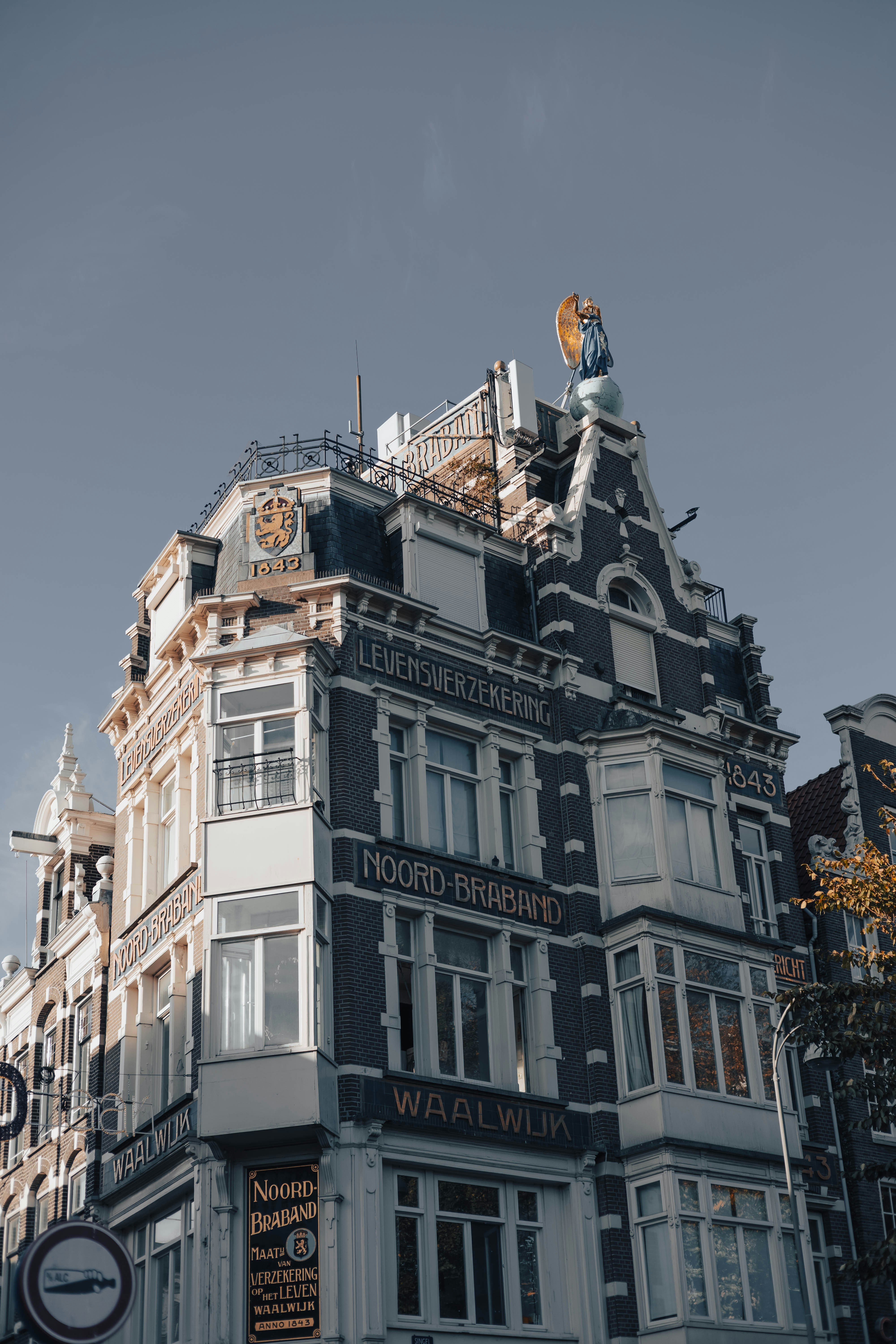 Historic Dutch Corner Tower: Facades and Gilded Crest