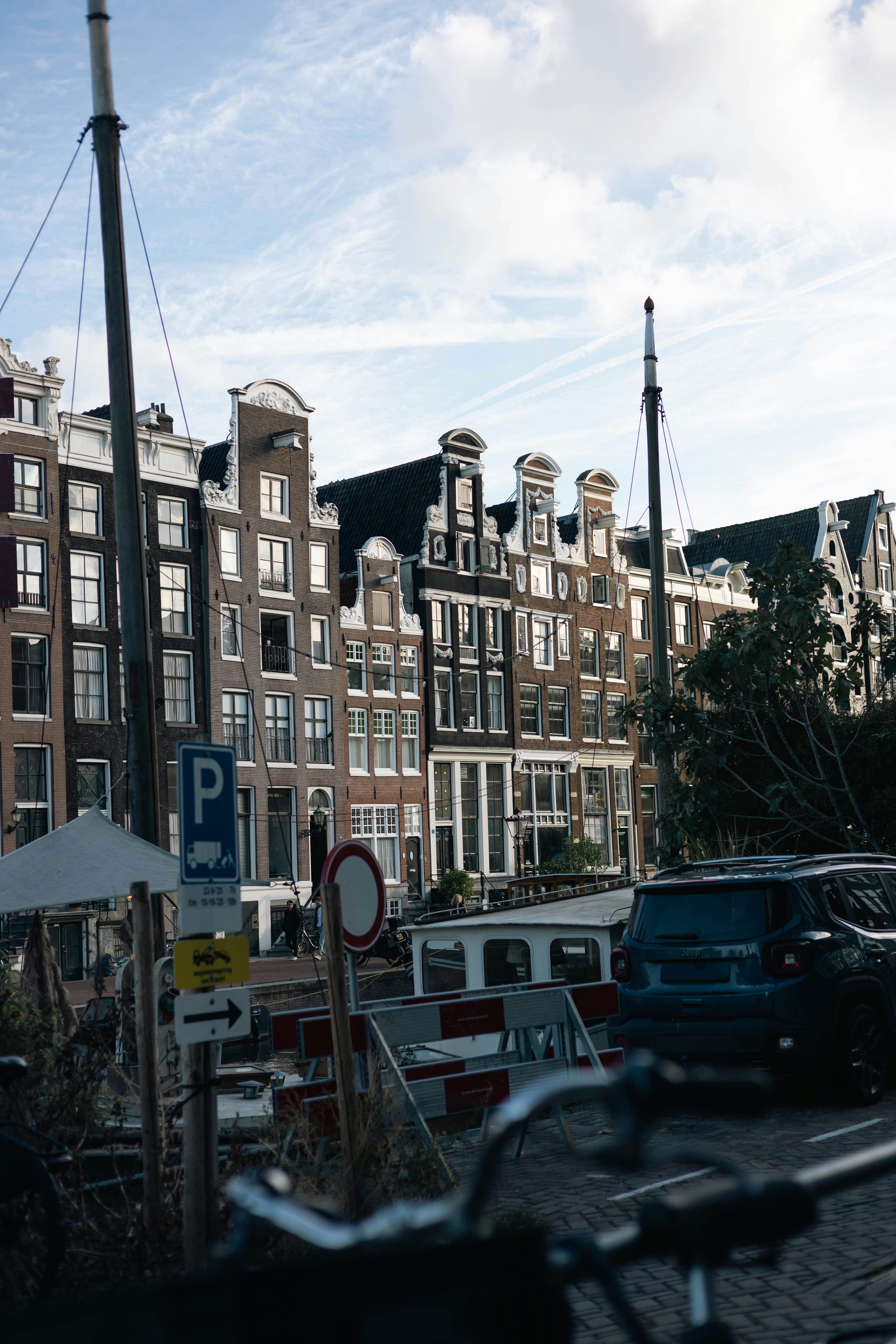 Canal-side Facades under a Bright Amsterdam Sky