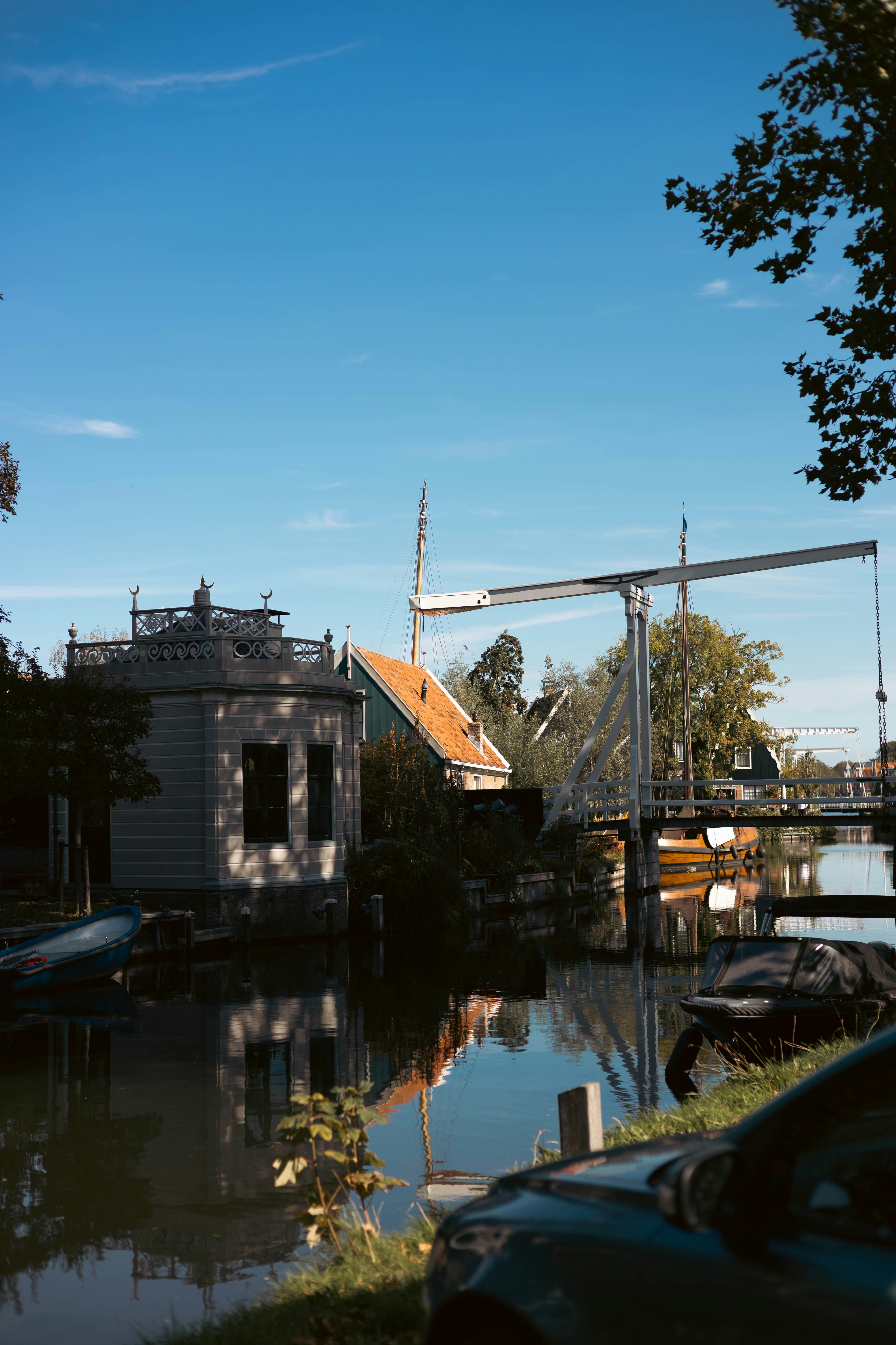 Quiet Canal Harvest: A Dutch-Influenced Scene with Floating House and Drawbridge