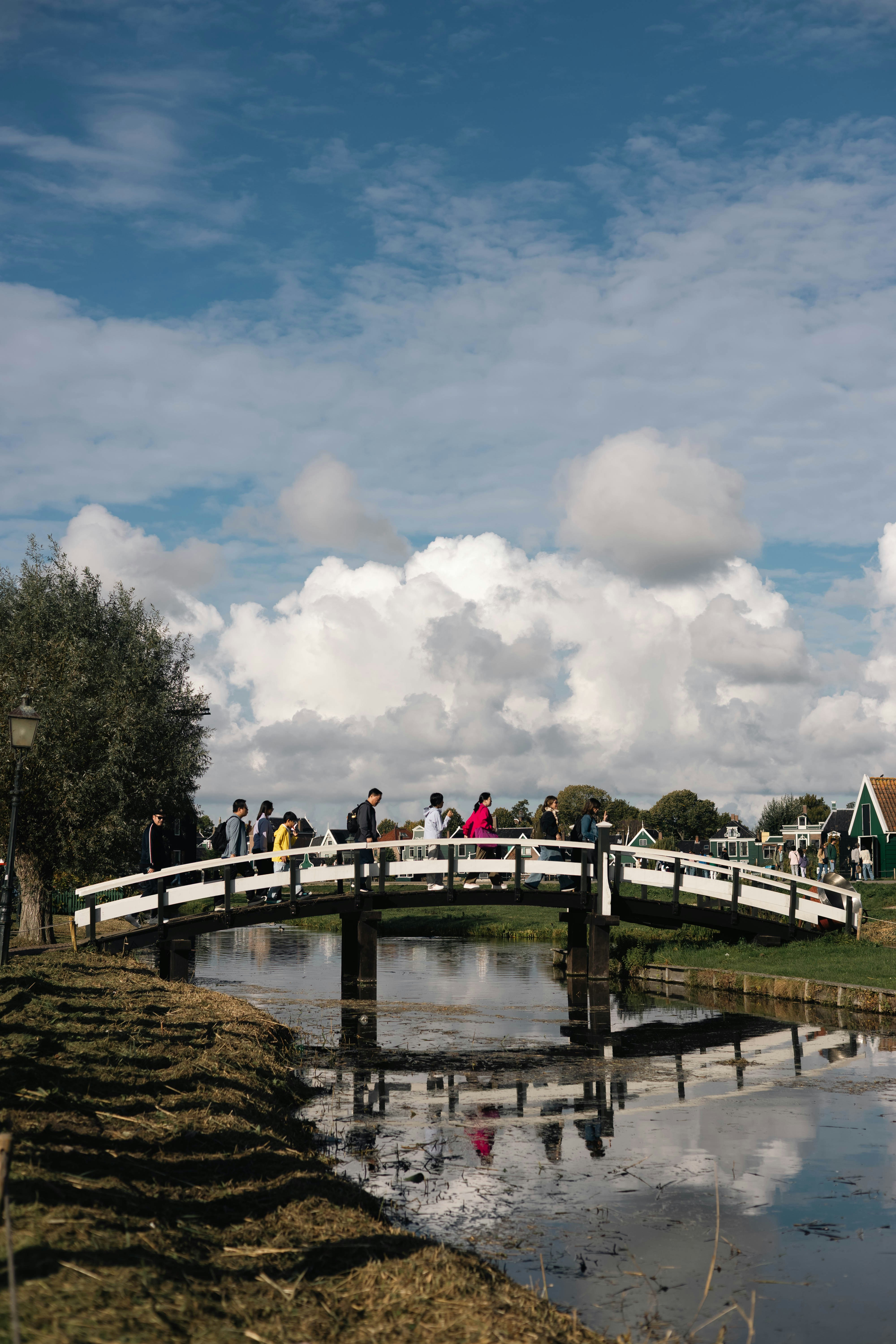 Bridge Crowd under a Sky of Puffs