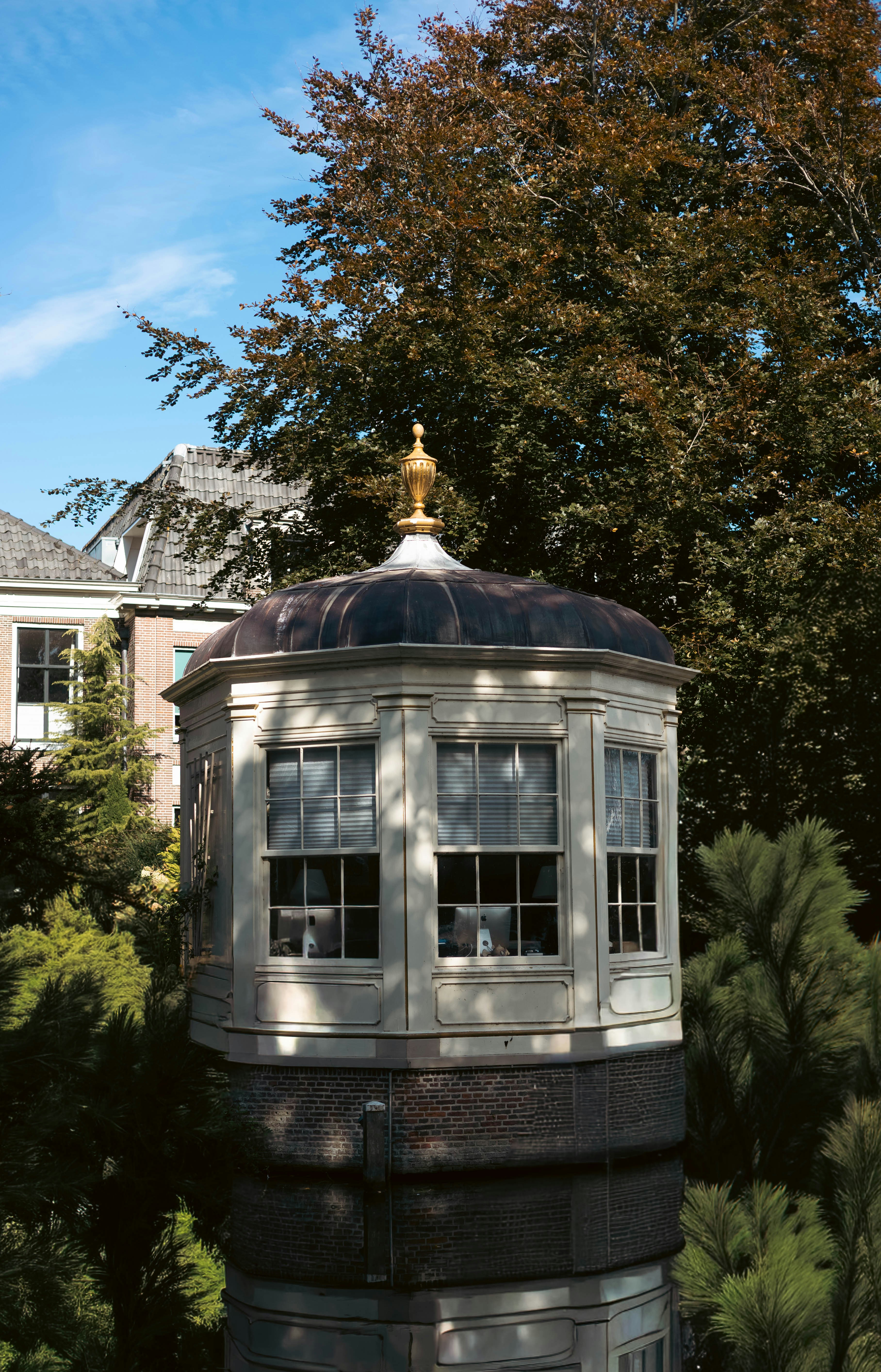 Ornate Gazebo Crowned by a Golden Finial Surrounded by Autumnal Foliage