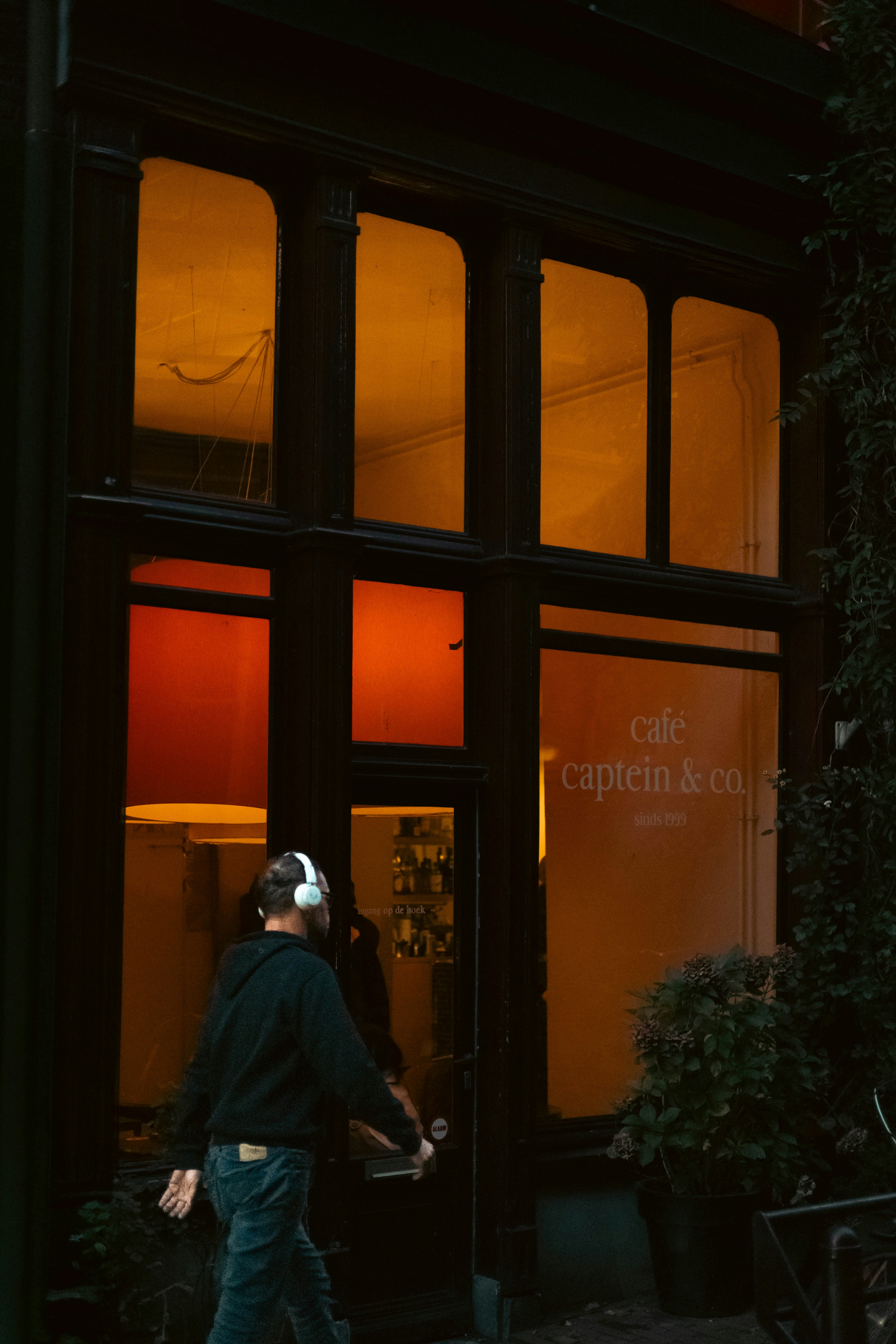 Warm Café Window: A Listener in the Orange Glow