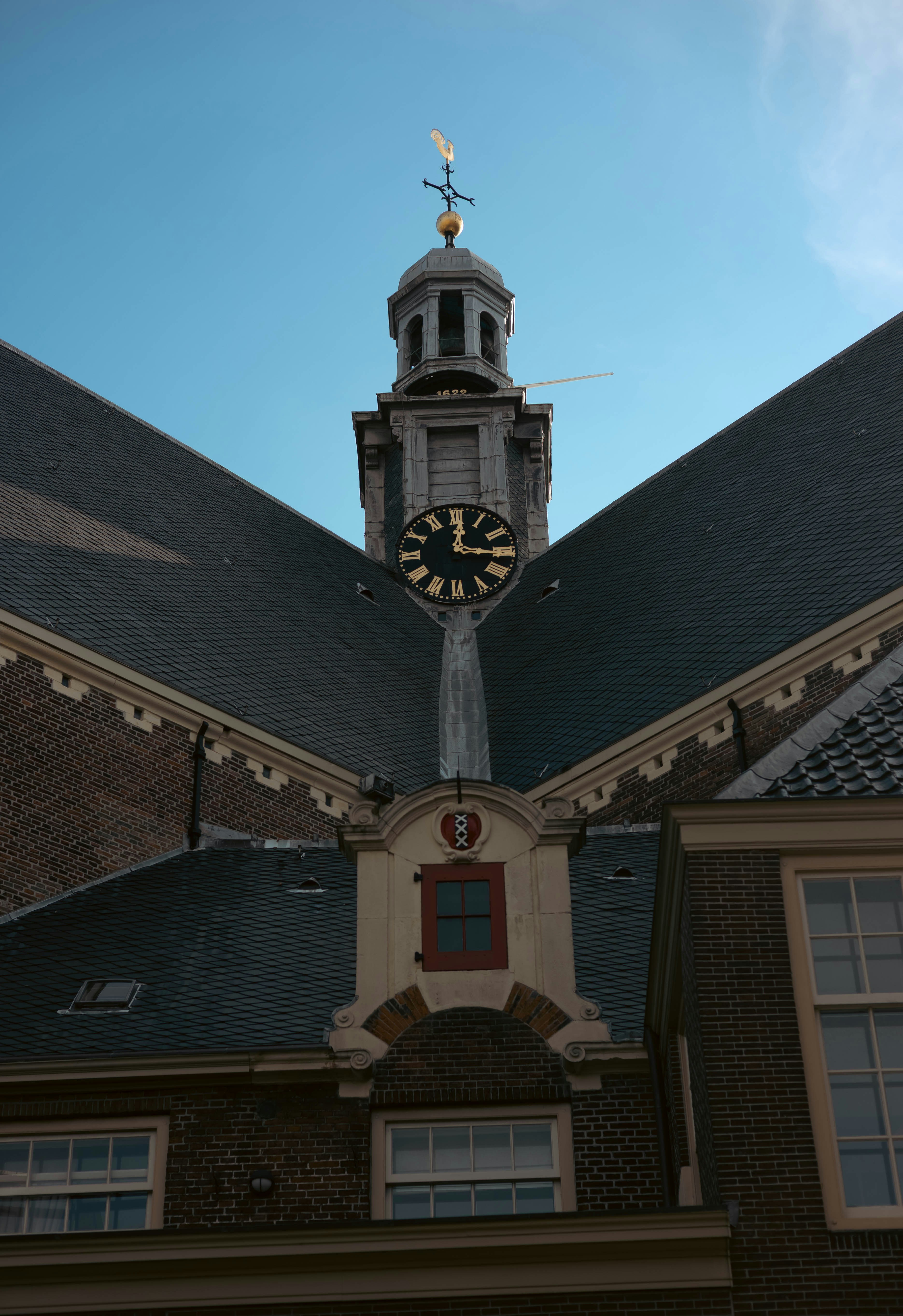 Clock tower crown against a clear morning sky