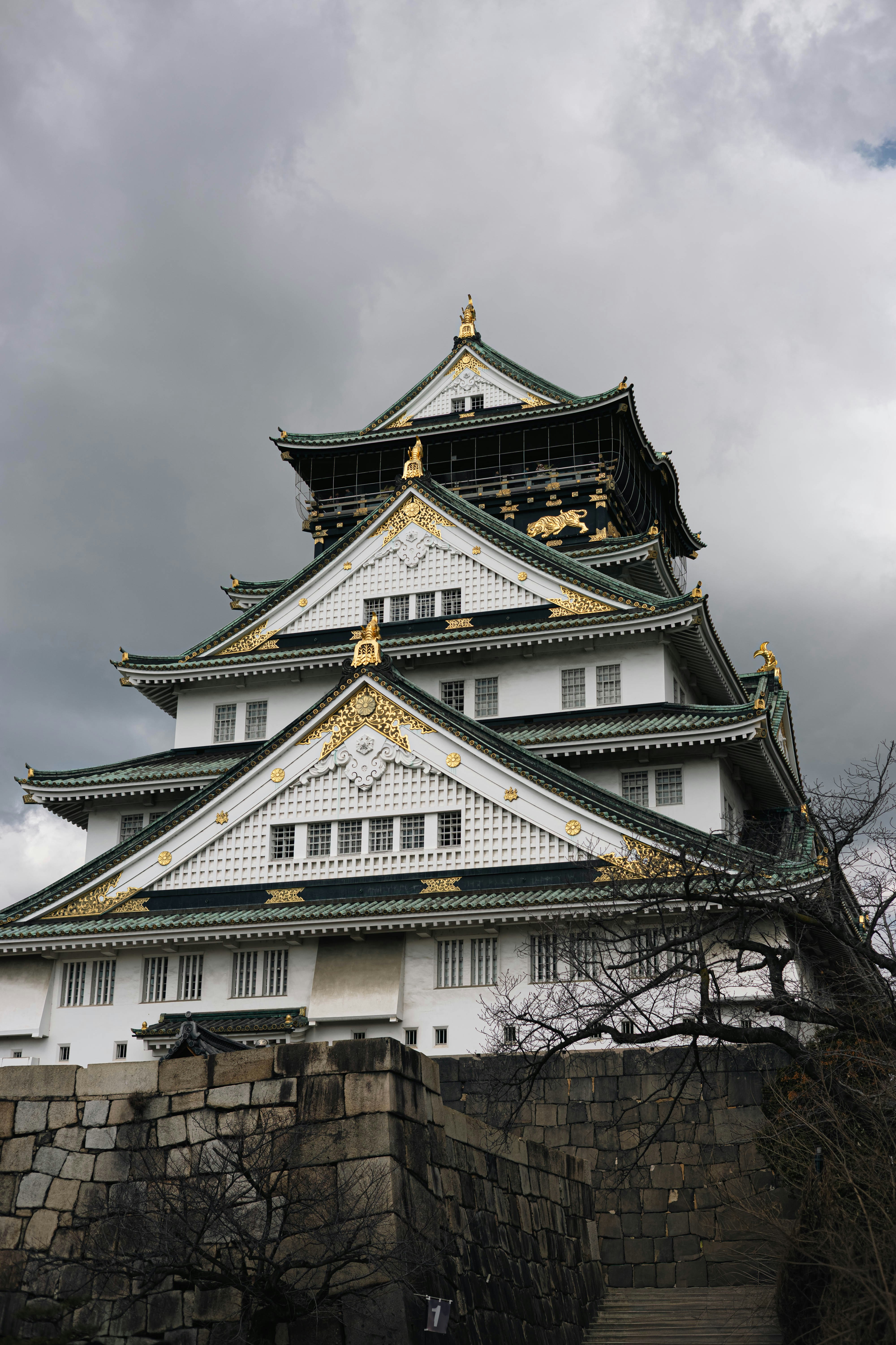 Stonebound Summit: Osaka Castle Reaches Toward a Brooding Sky