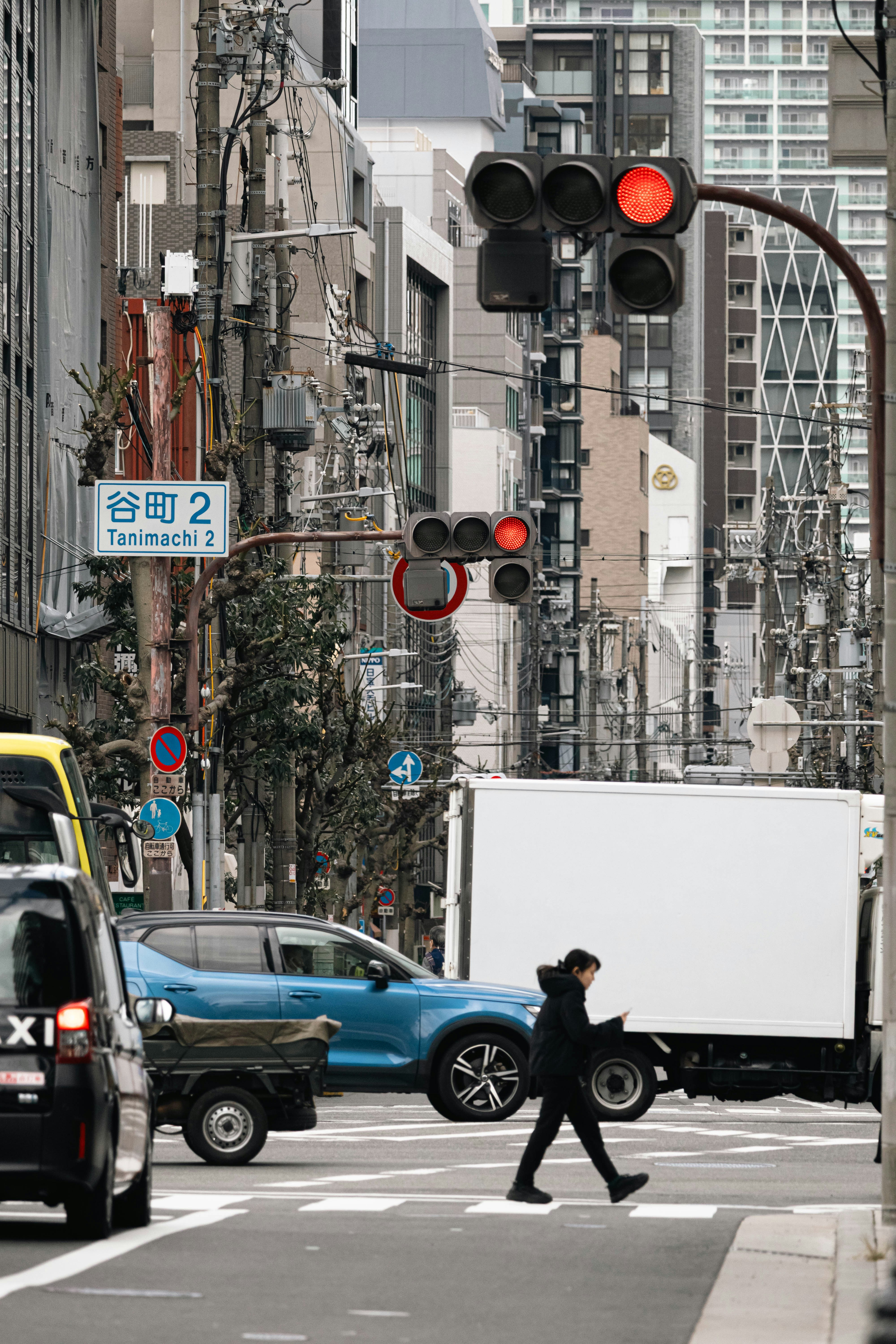 Crosswalk Moment: A Pedestrian Bridges the Street Amid Urban Rhythm