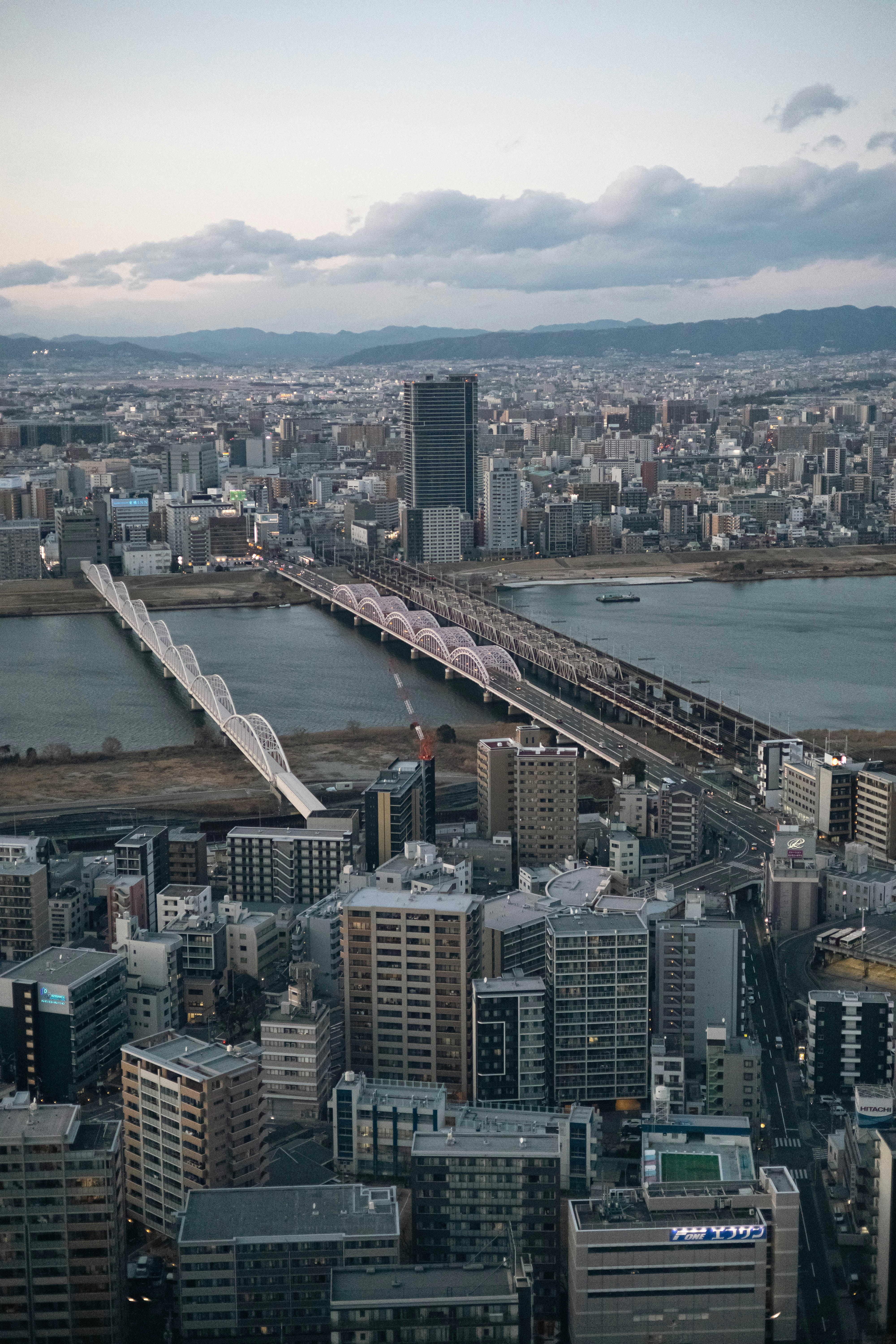 Bridge Over a Densely Packed Cityscape at Dusk