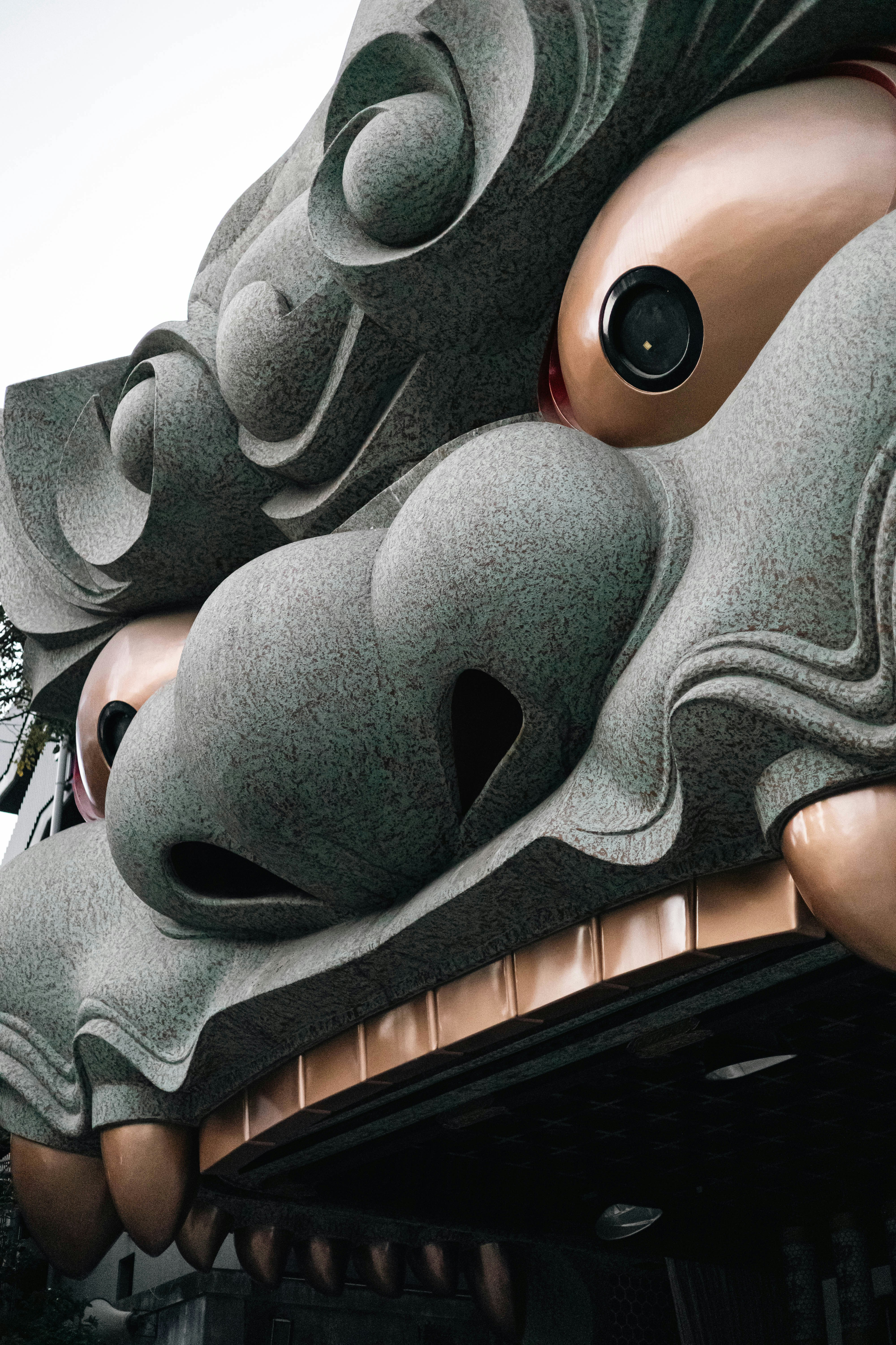 Gigantic Stone Dragon Head as Urban Sculpture Looms Over the Street